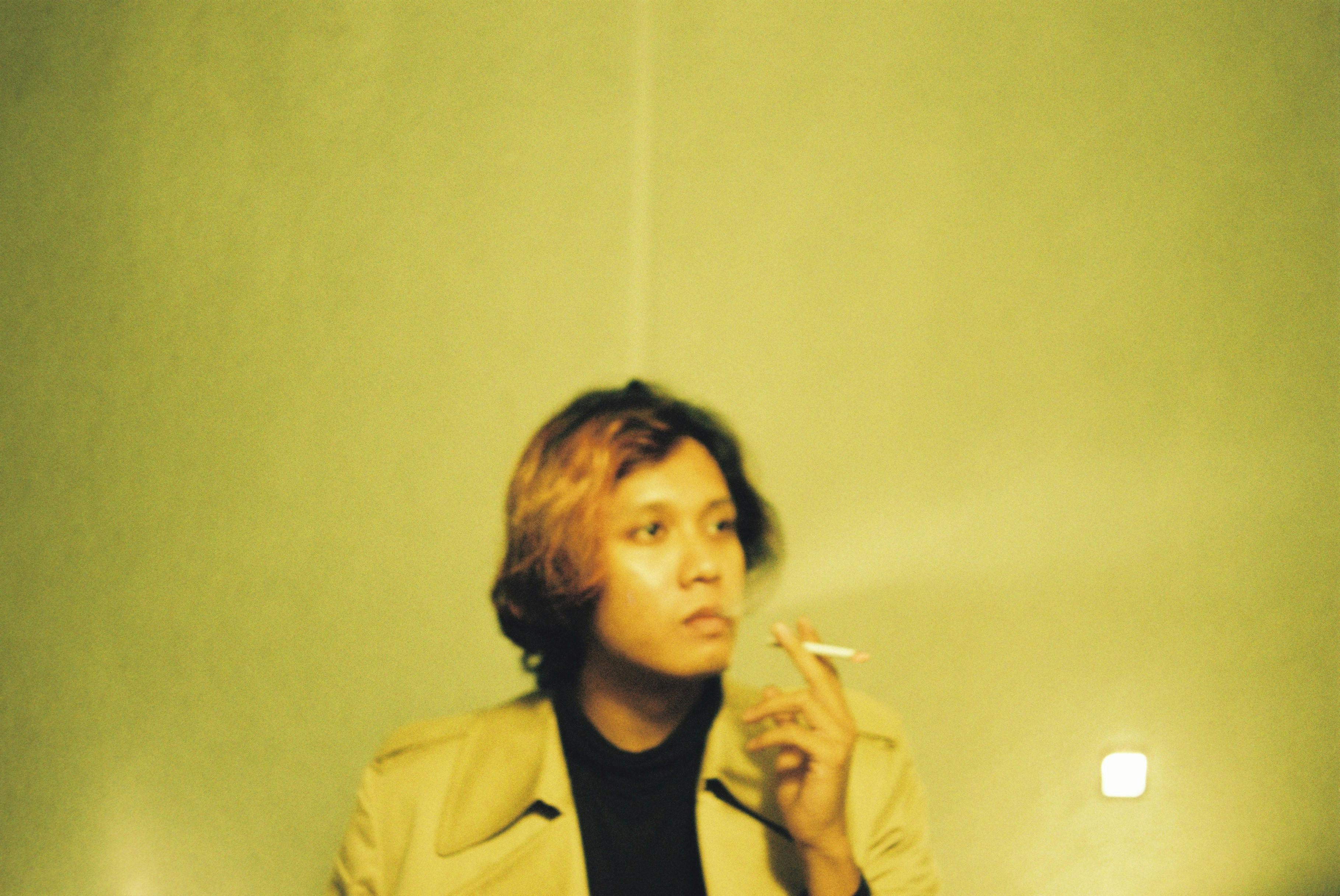 Back View of a Person Sitting Smoking · Free Stock Photo