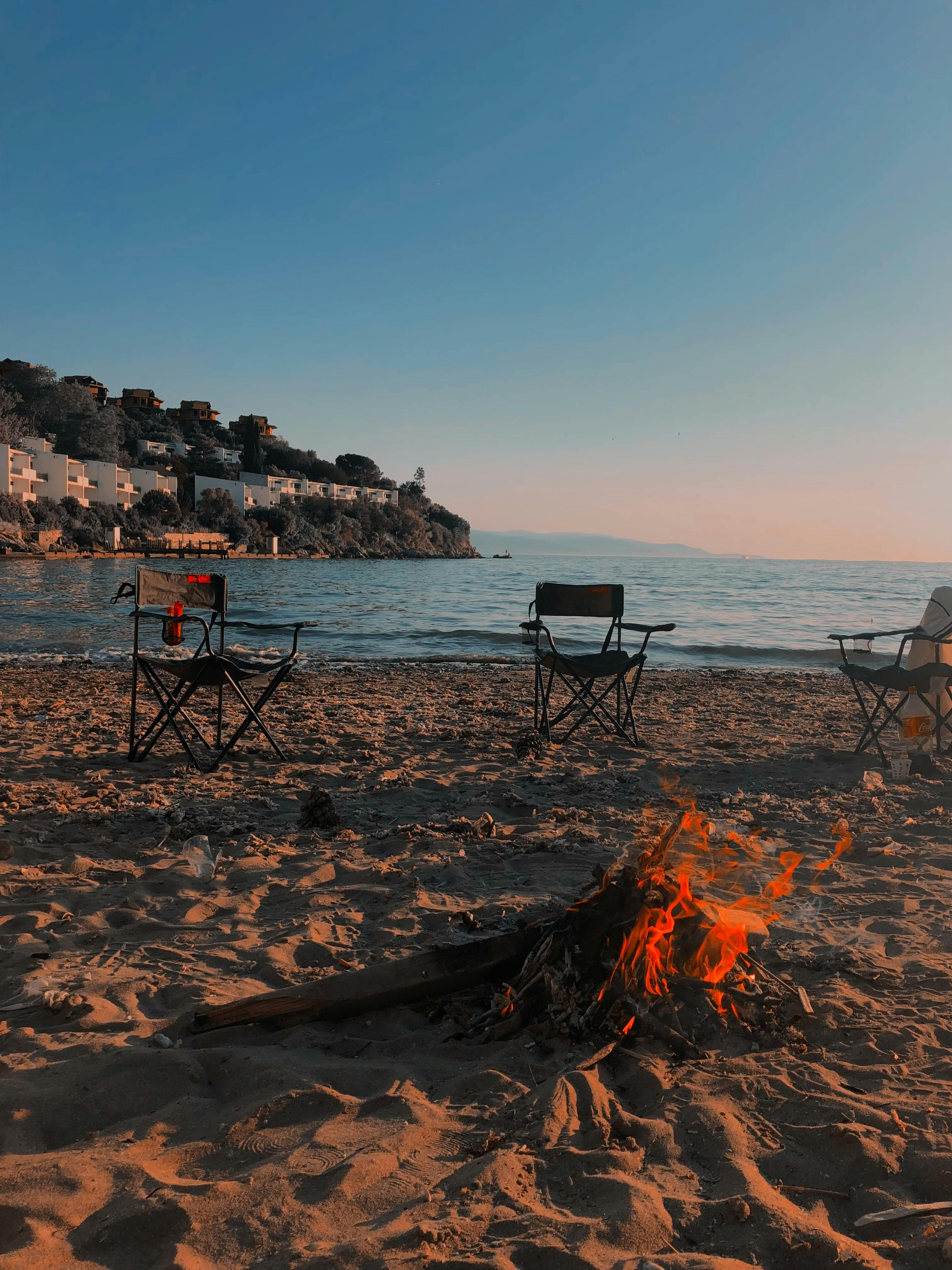 A Bonfire and Chair on the Sand · Free Stock Photo