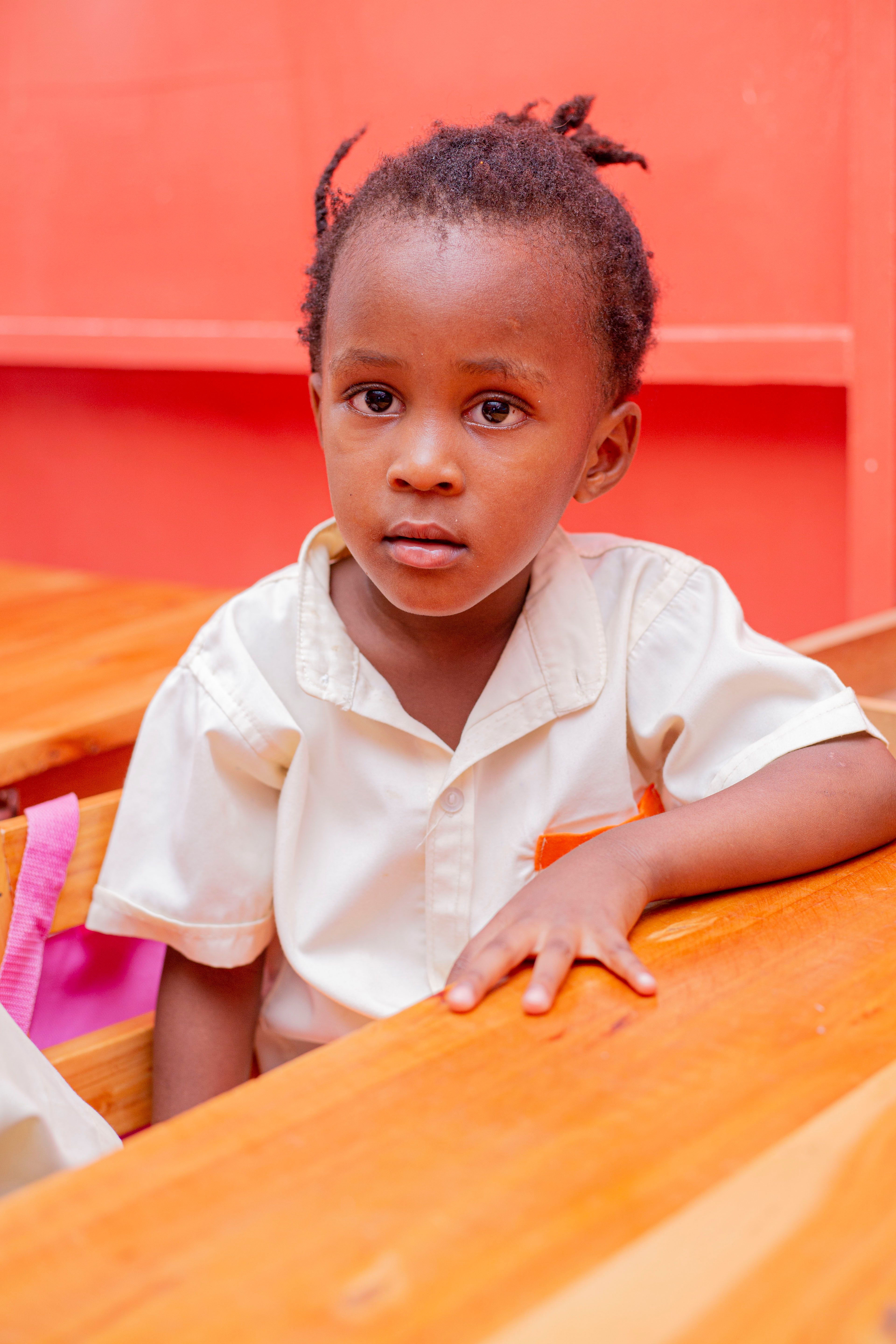Little Boy Sitting by the Wooden Table · Free Stock Photo