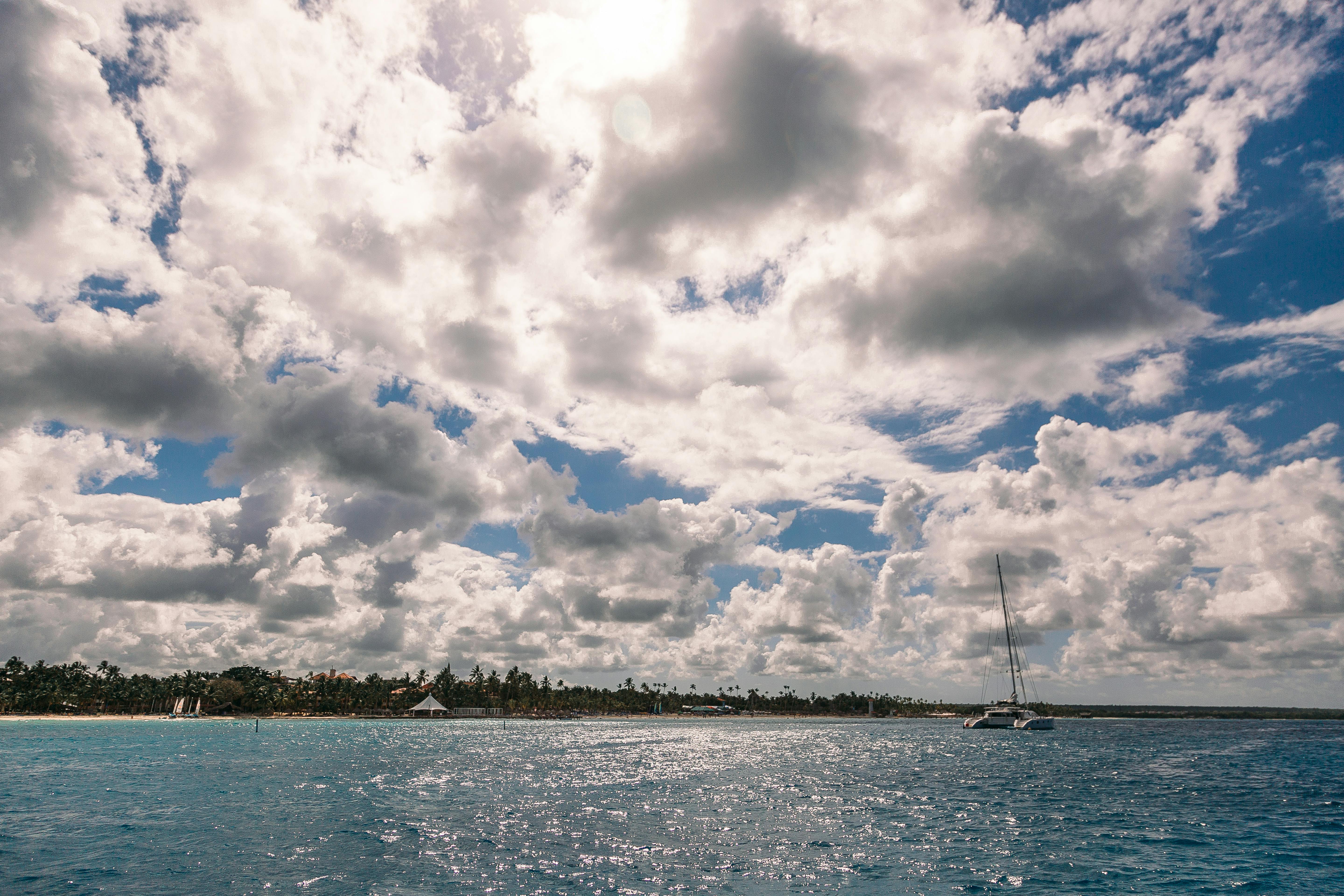 Sunlight over City on Sea Shore at Sunset · Free Stock Photo