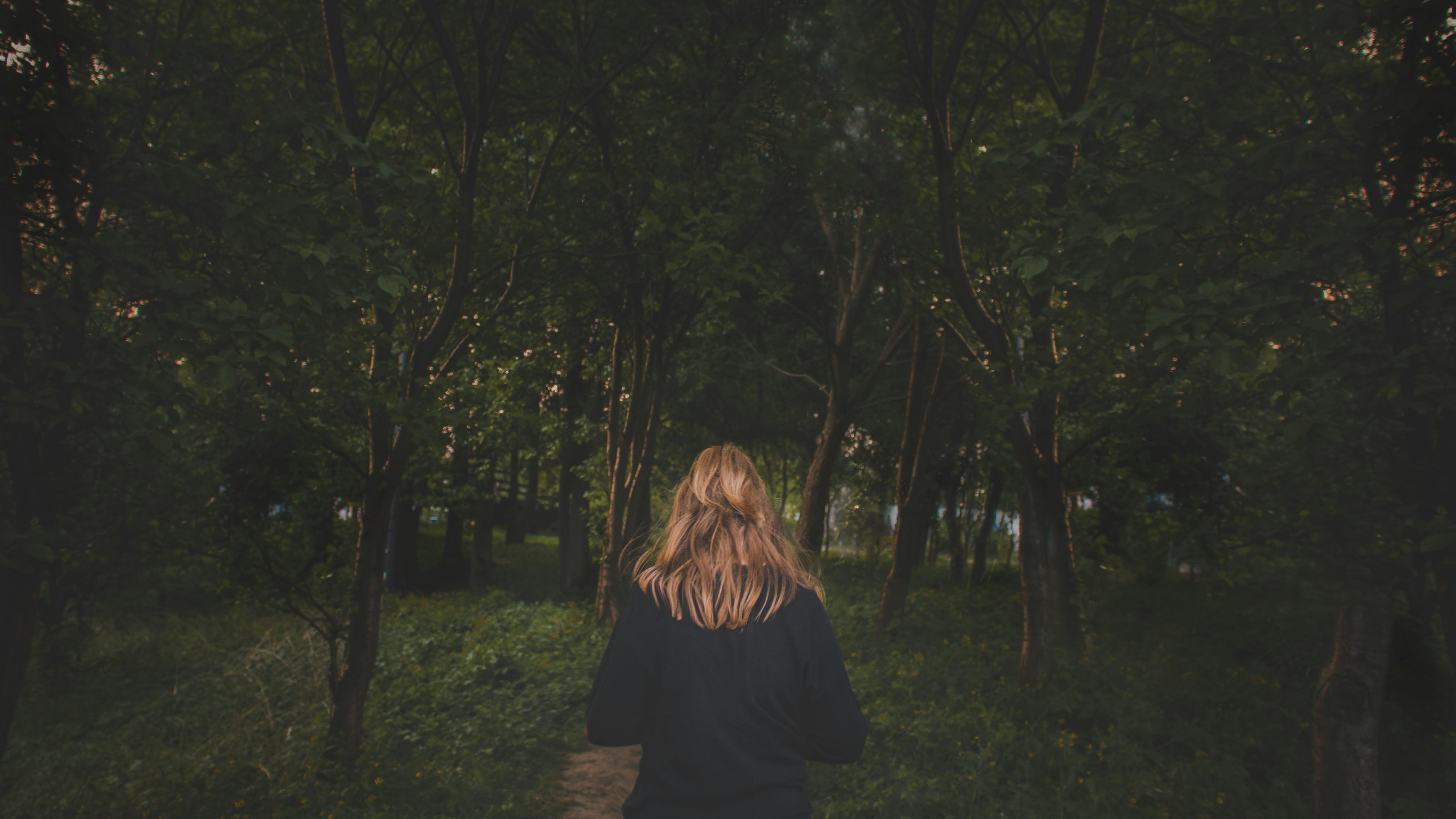 Woman Standing Beside Trees · Free Stock Photo
