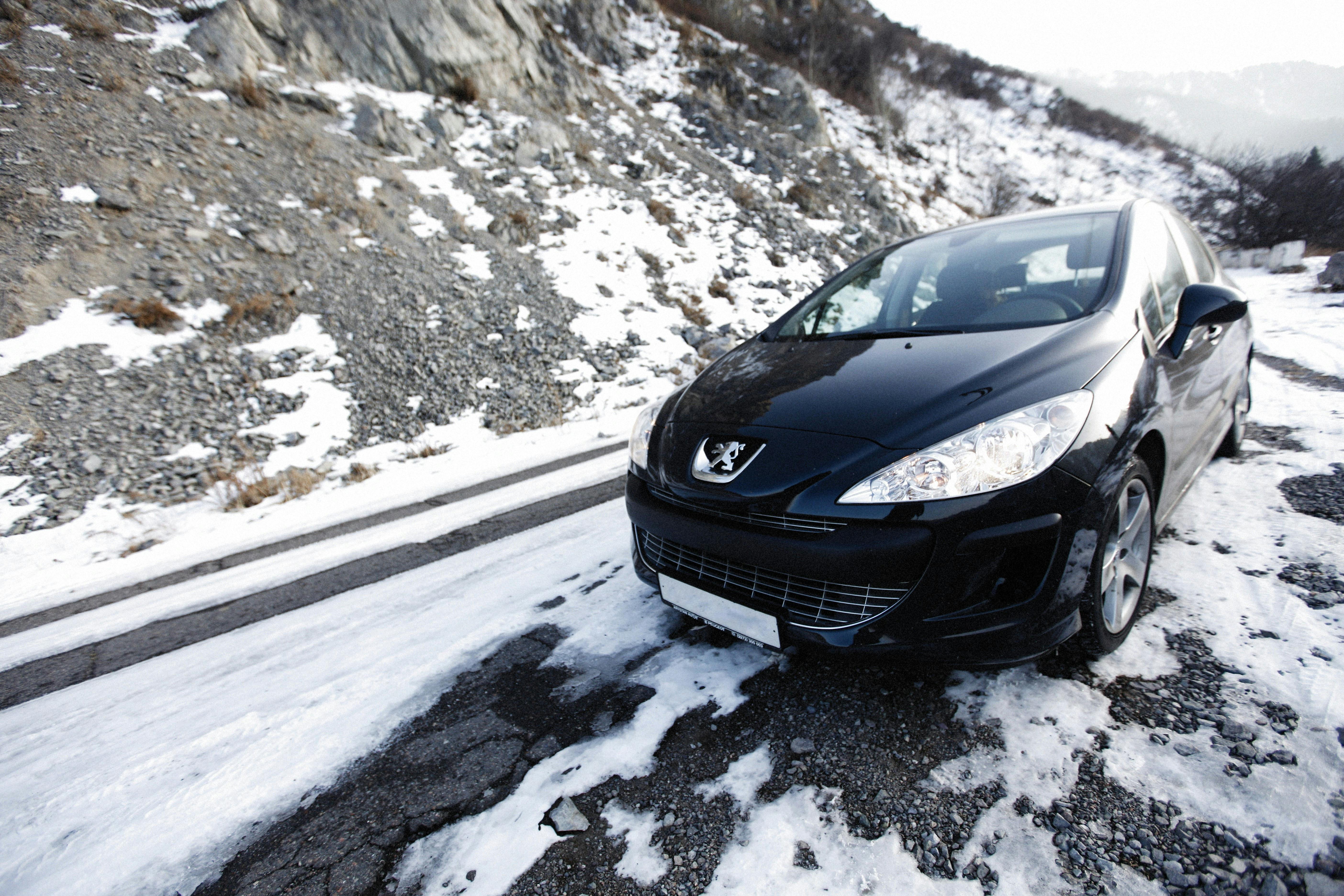 A Black Car on a Snowy Road · Free Stock Photo