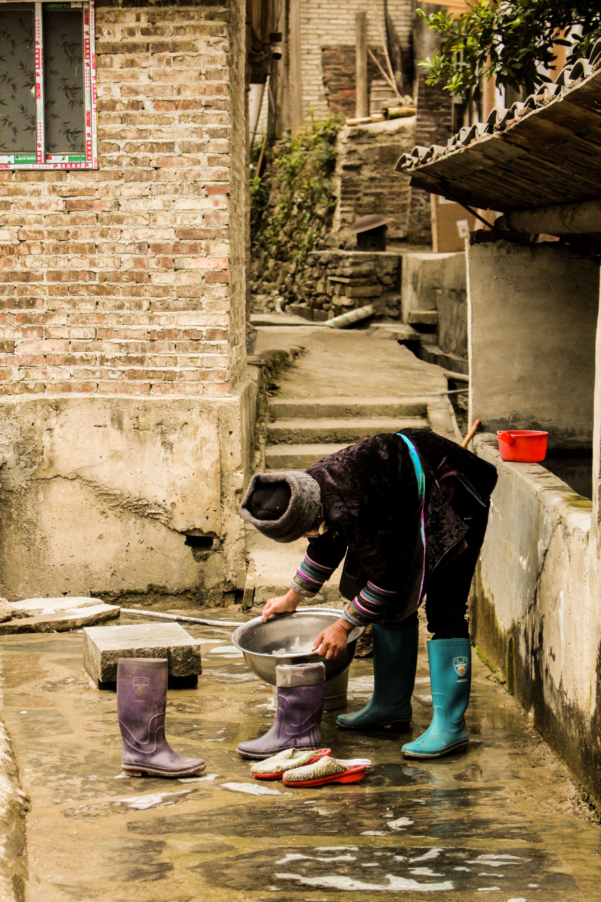Person Cleaning Shoes on Street in China · Free Stock Photo