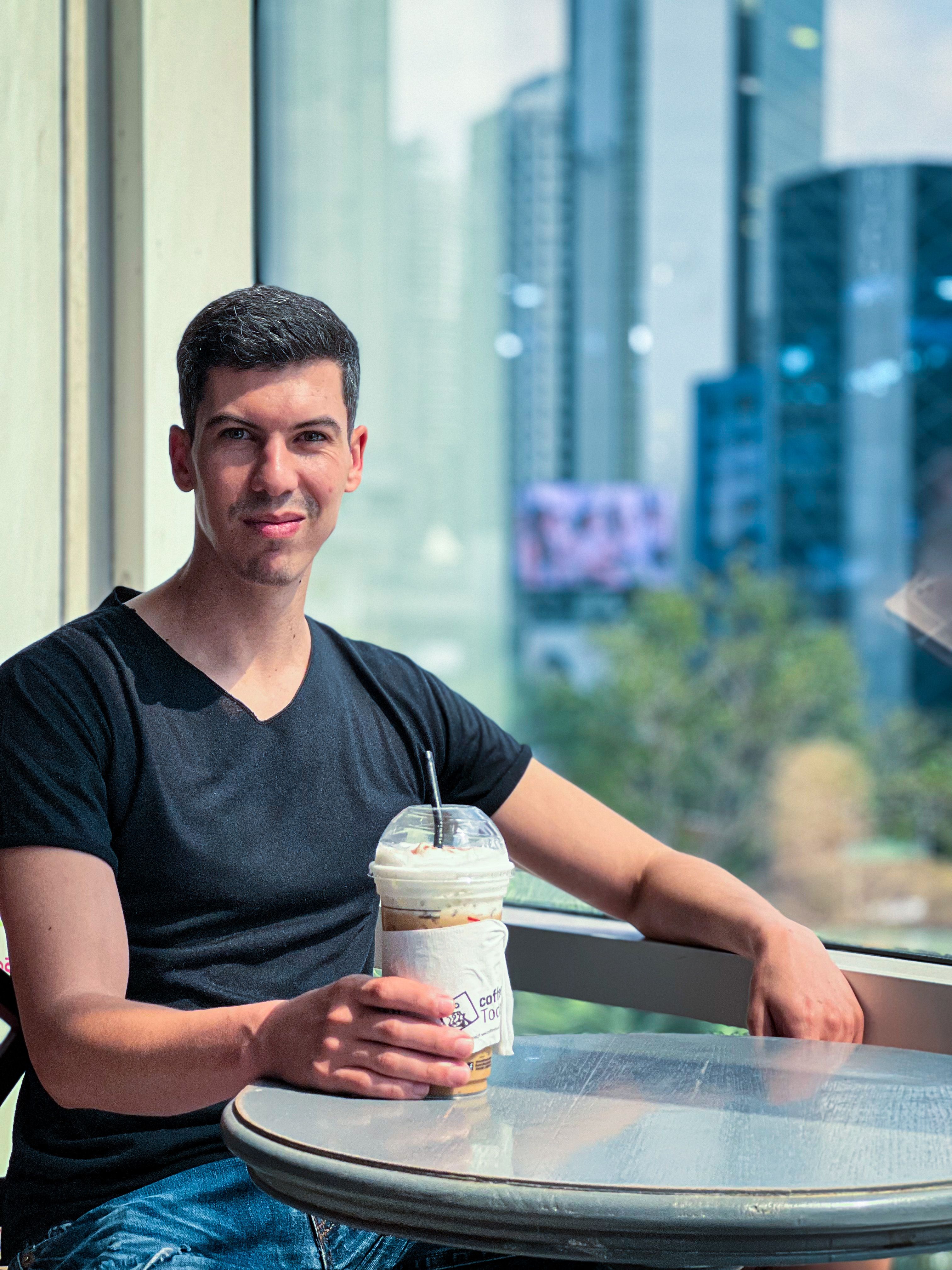 Man Holding Coffee and Smiling · Free Stock Photo