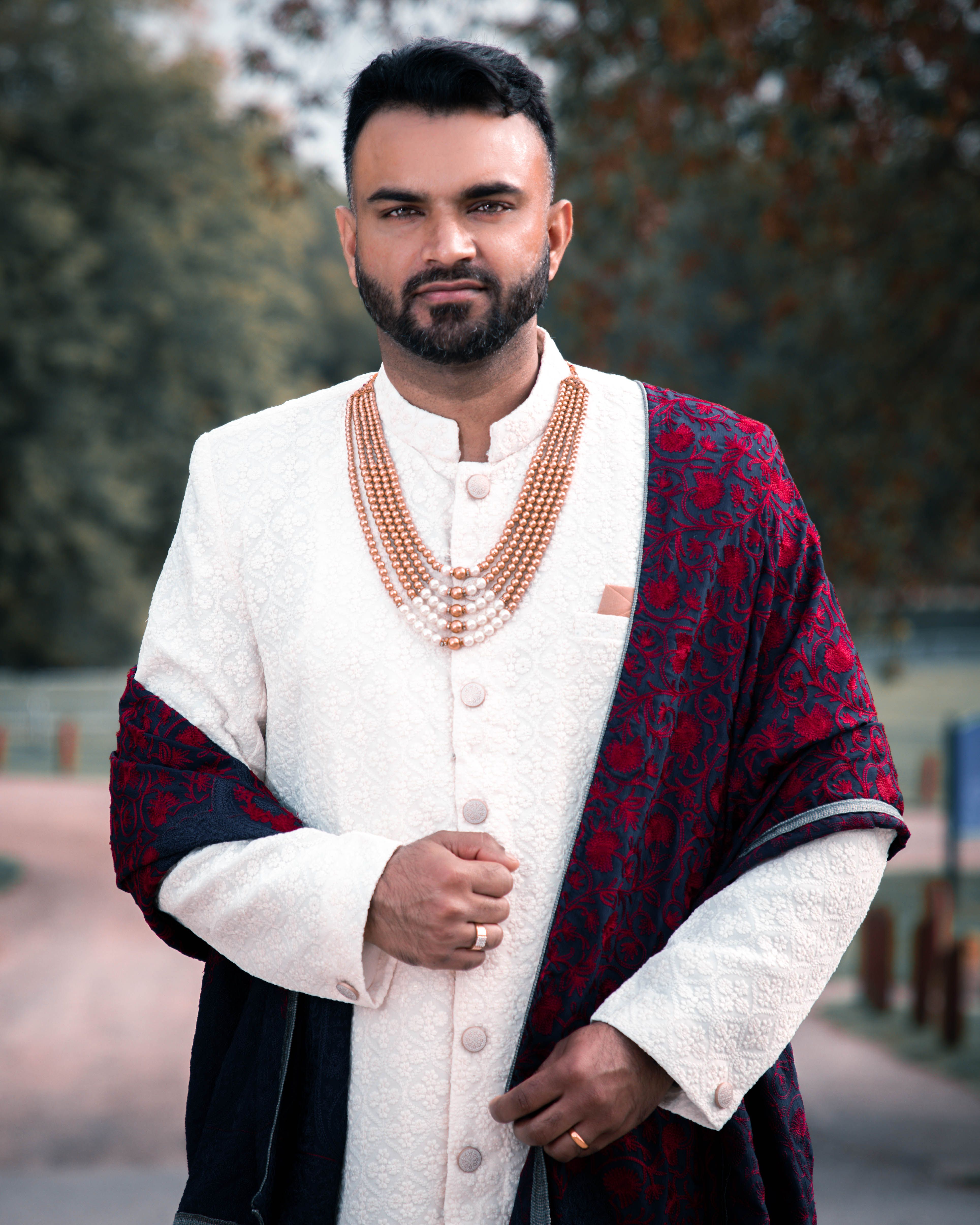 Groom Standing in White Jodhpuri Suit Holding a Cane · Free Stock Photo