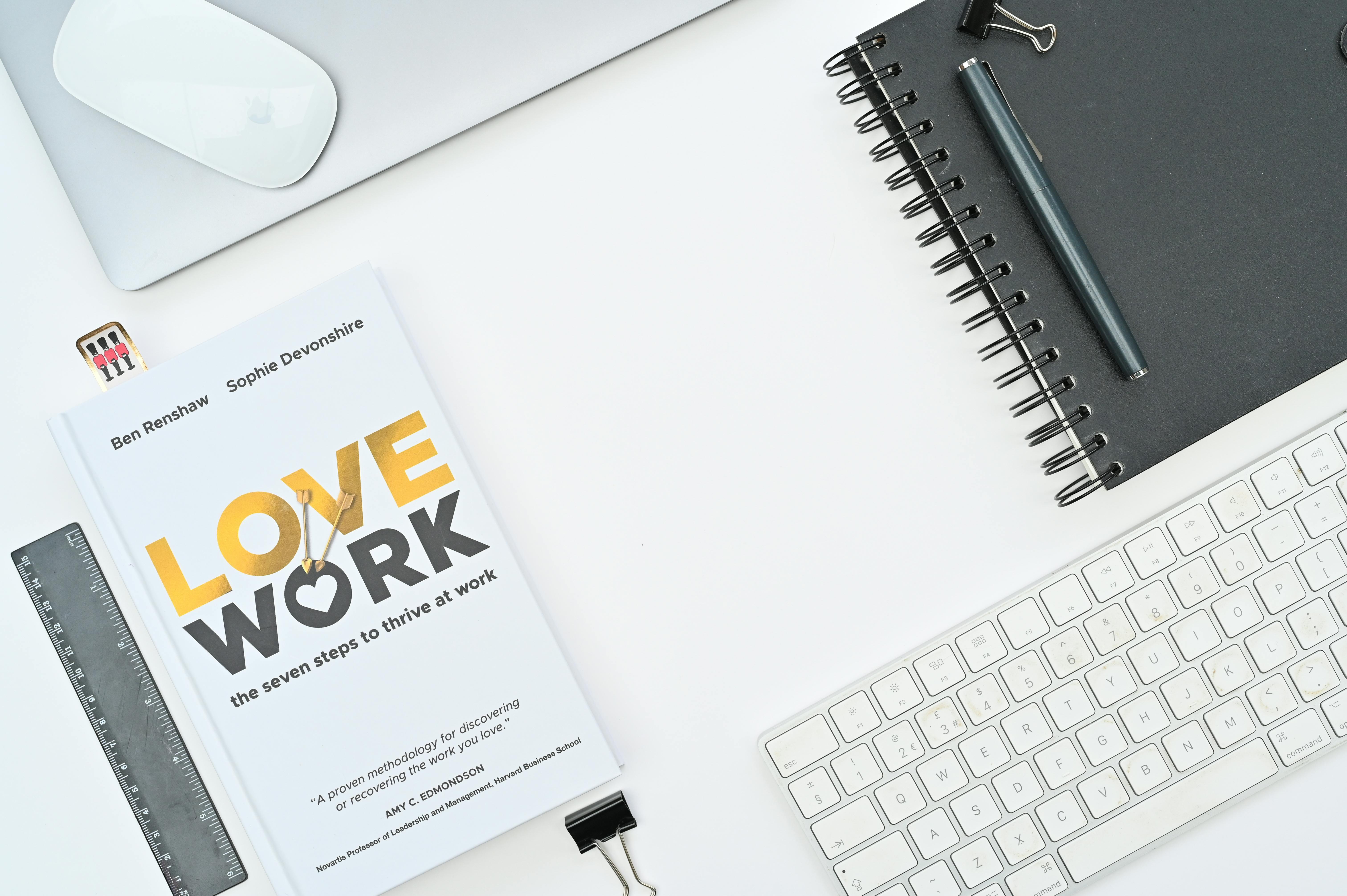 Book Beside a Laptop and Keyboard · Free Stock Photo