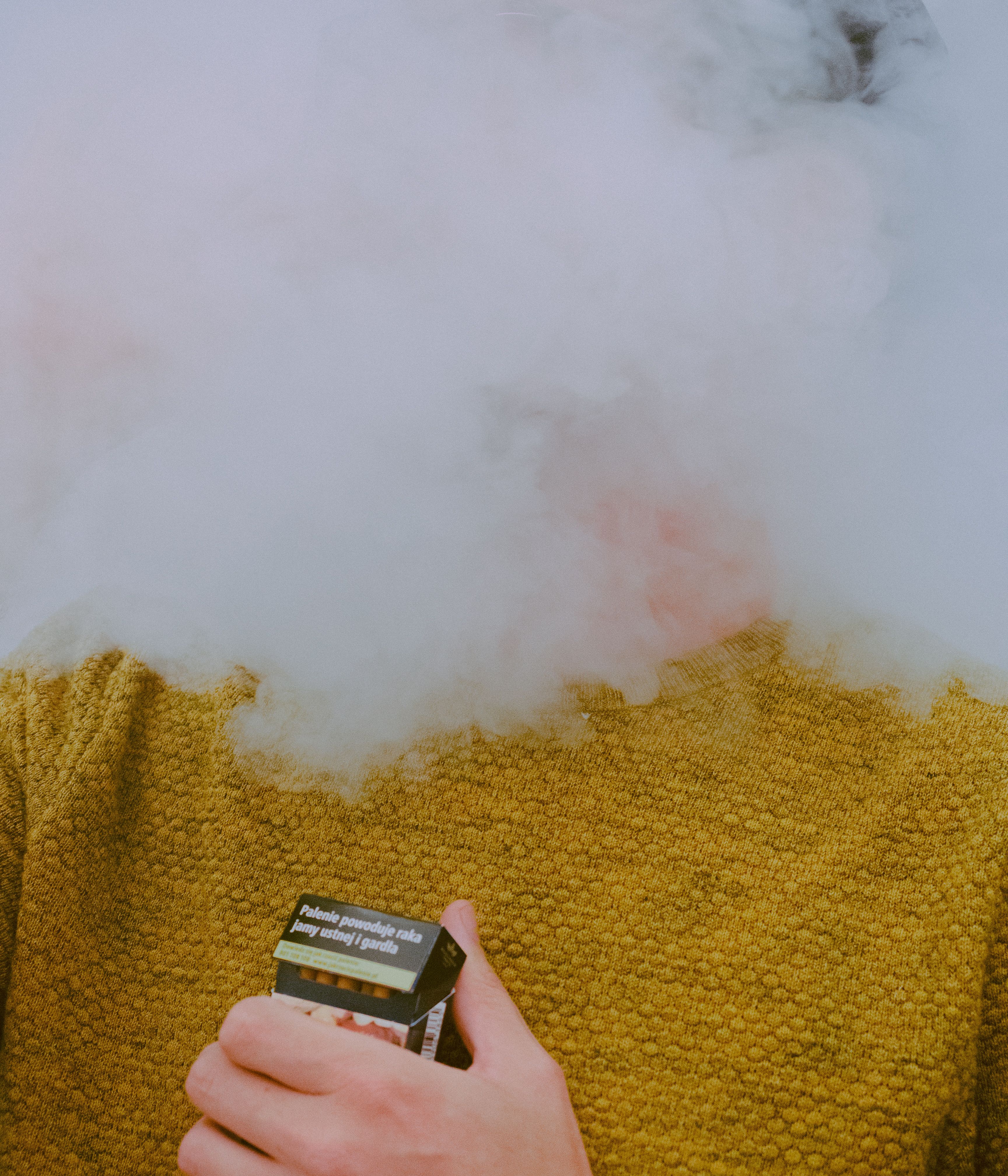 Person in Black Fur Jacket and a Mask Smoking a Cigarette · Free Stock ...
