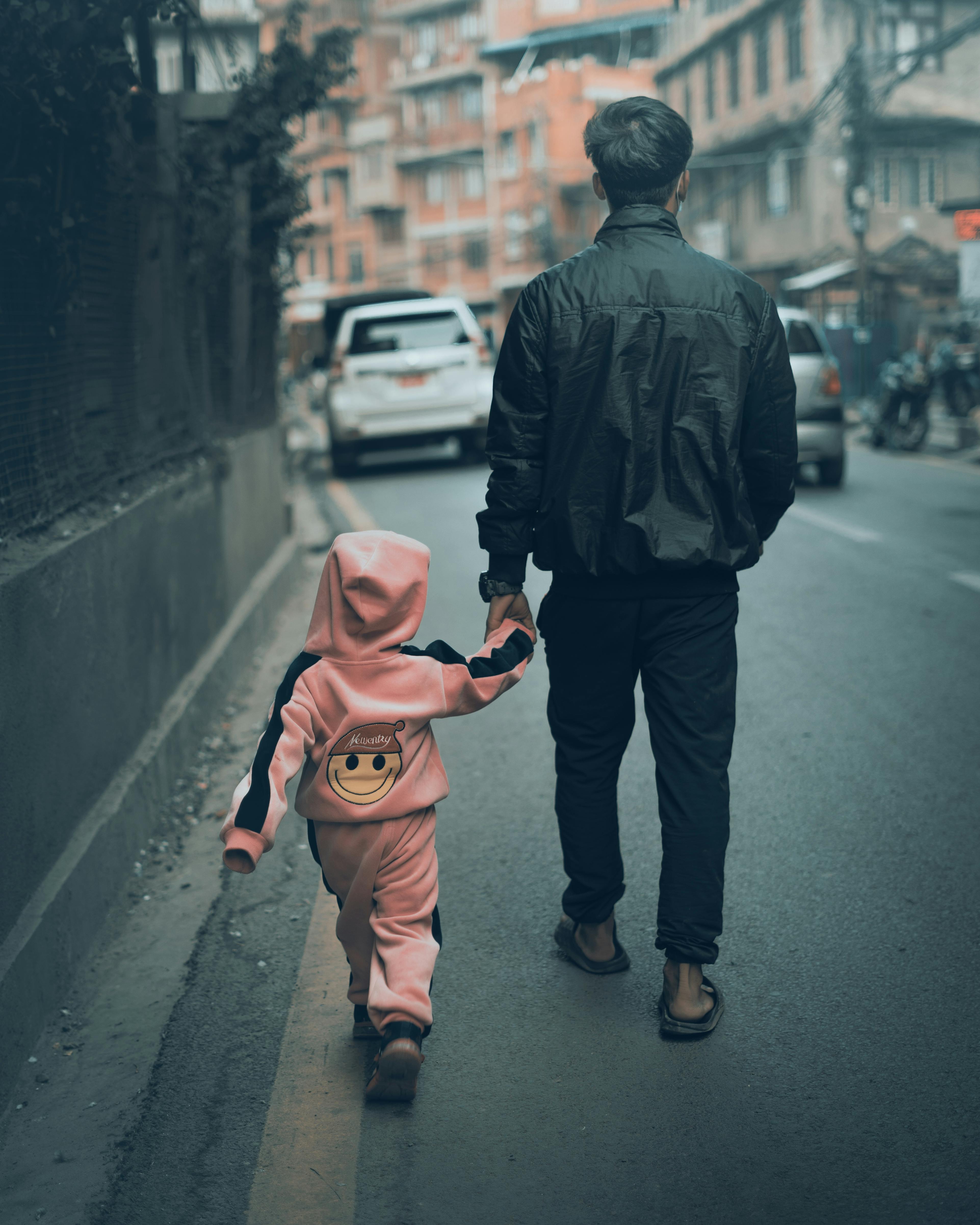 Man Walking with Child on Street · Free Stock Photo