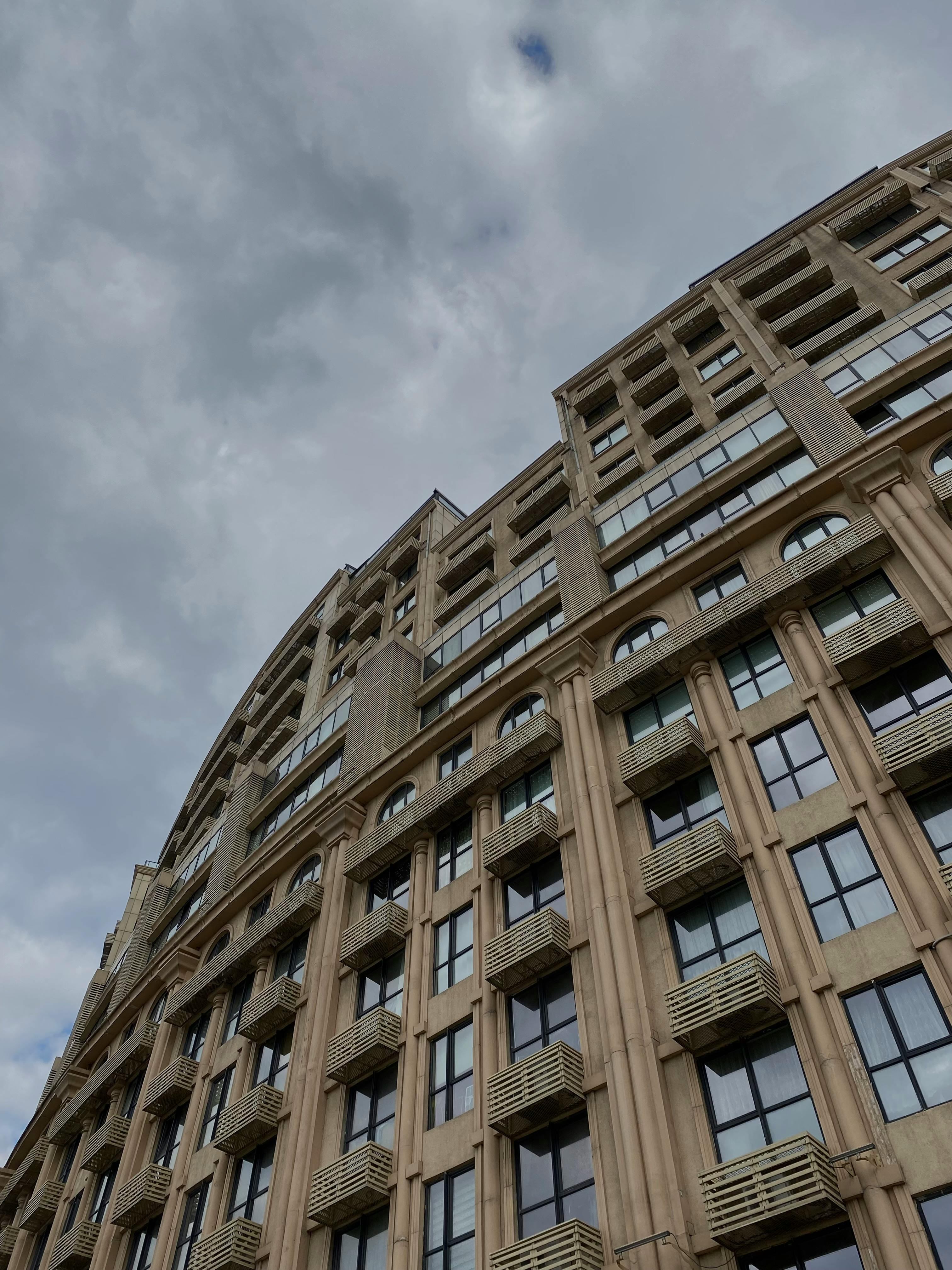Glass Panel Windows of a Tall Building · Free Stock Photo