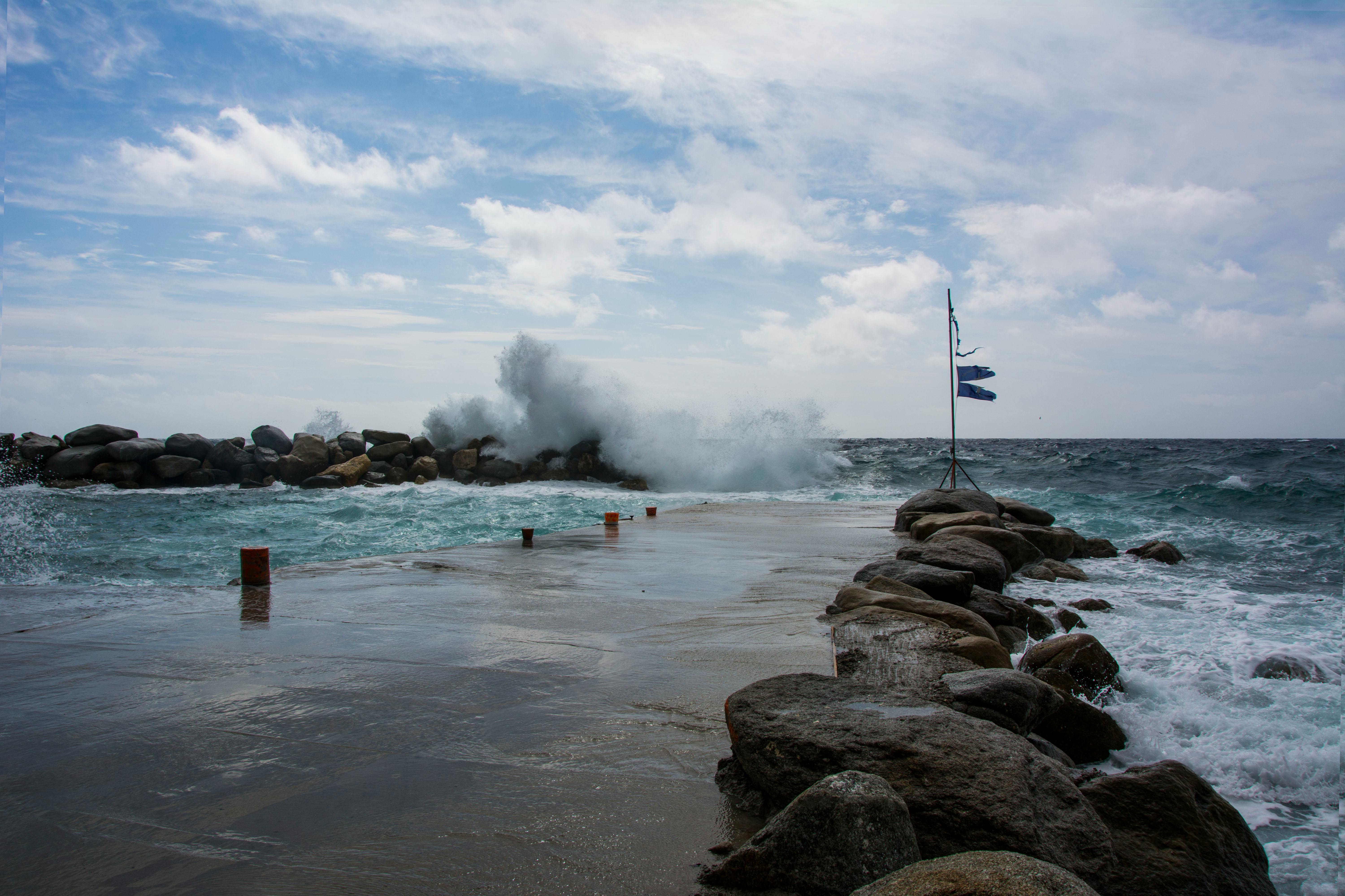 Pier with Stones and Storm on the Sea · Free Stock Photo