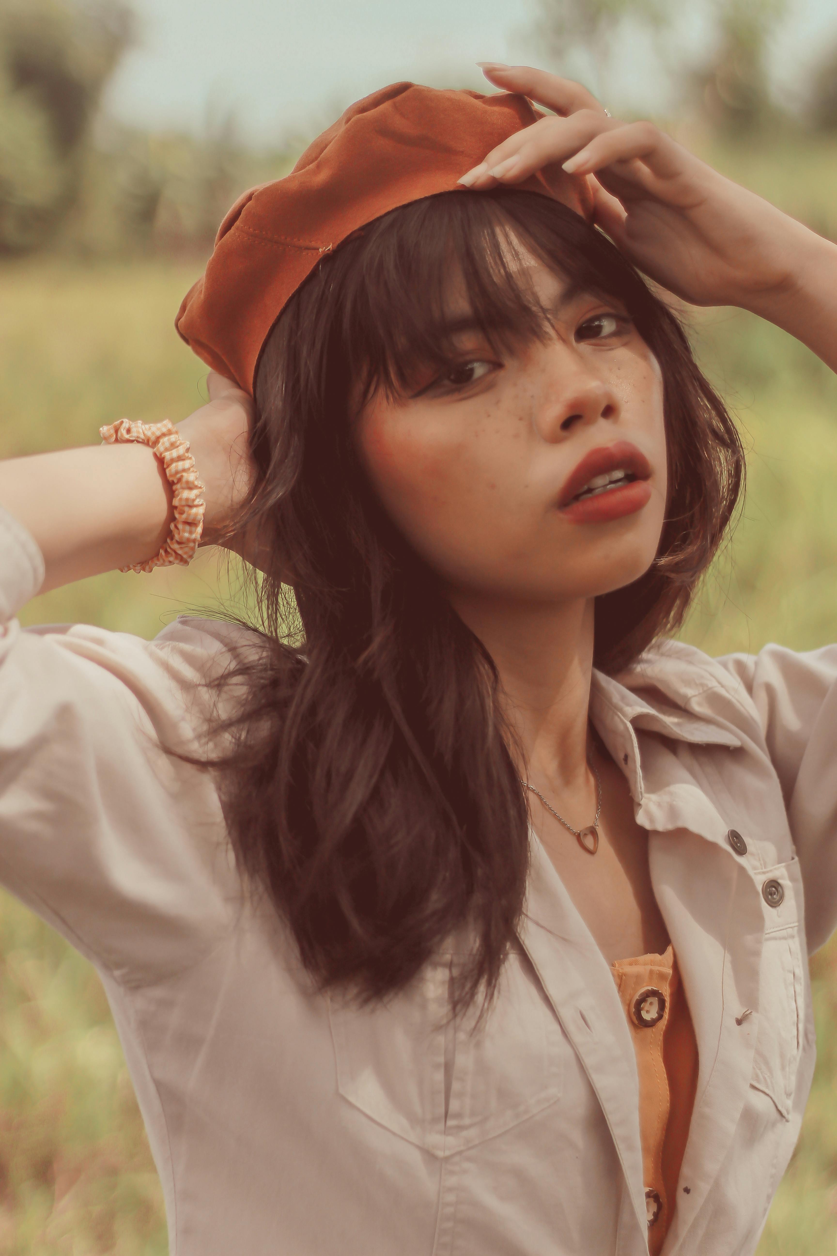 Woman in Brown Coat Wearing Pink Cap · Free Stock Photo