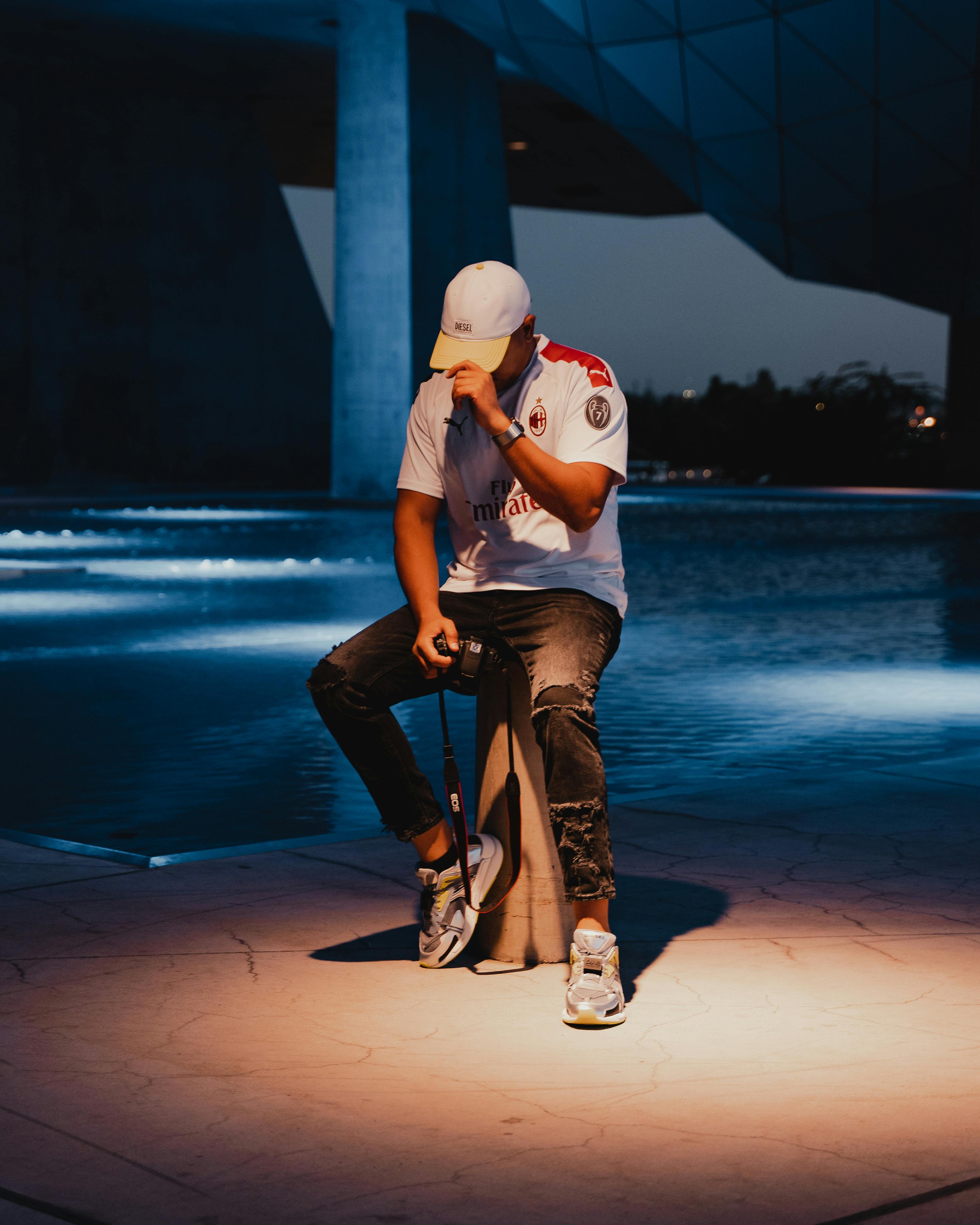 Photo of a Man with a Cap Posing Near Pipes · Free Stock Photo
