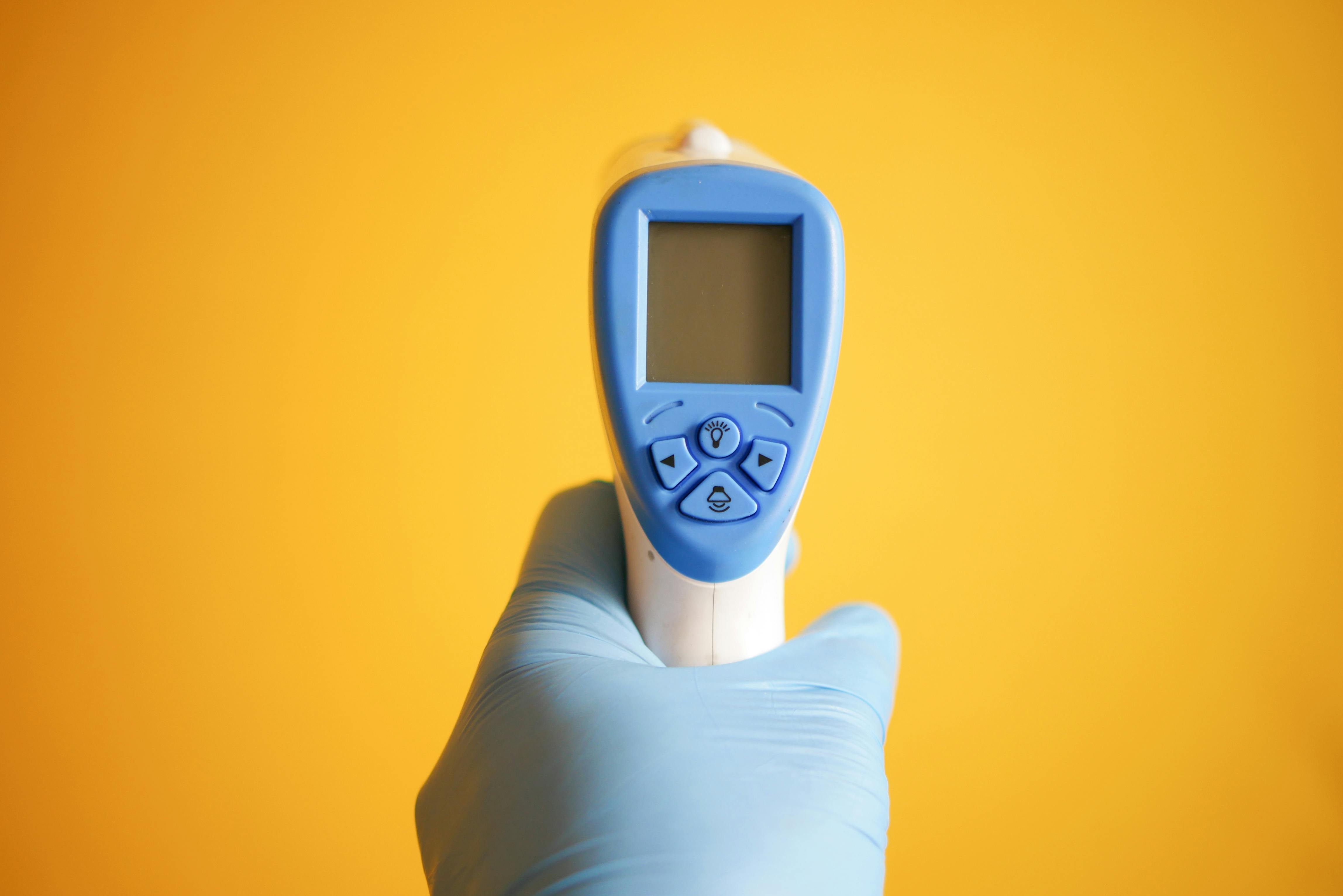 Person Holding a Glass Thermometer · Free Stock Photo