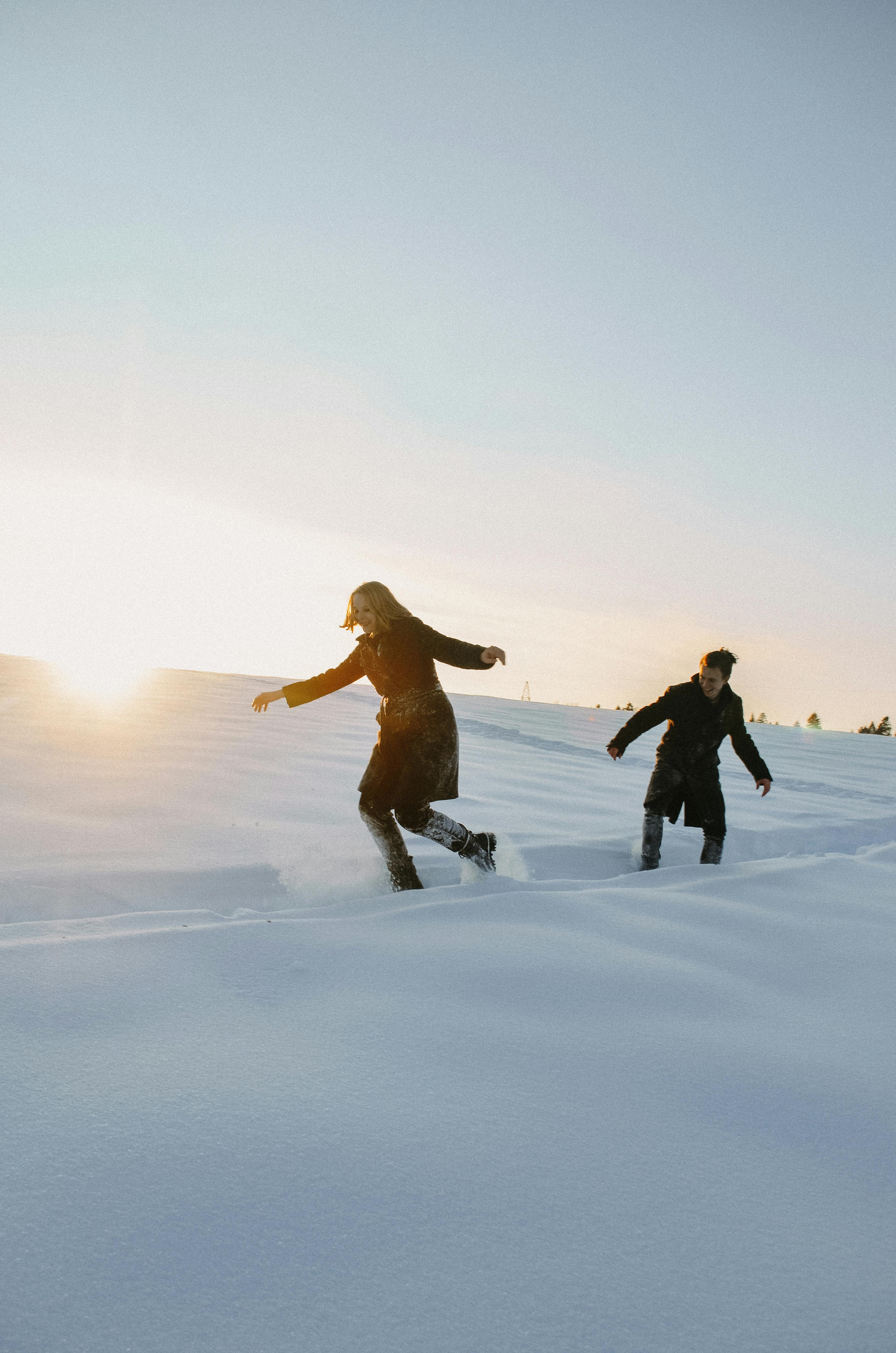 A Couple Playing on the Snow Together · Free Stock Photo