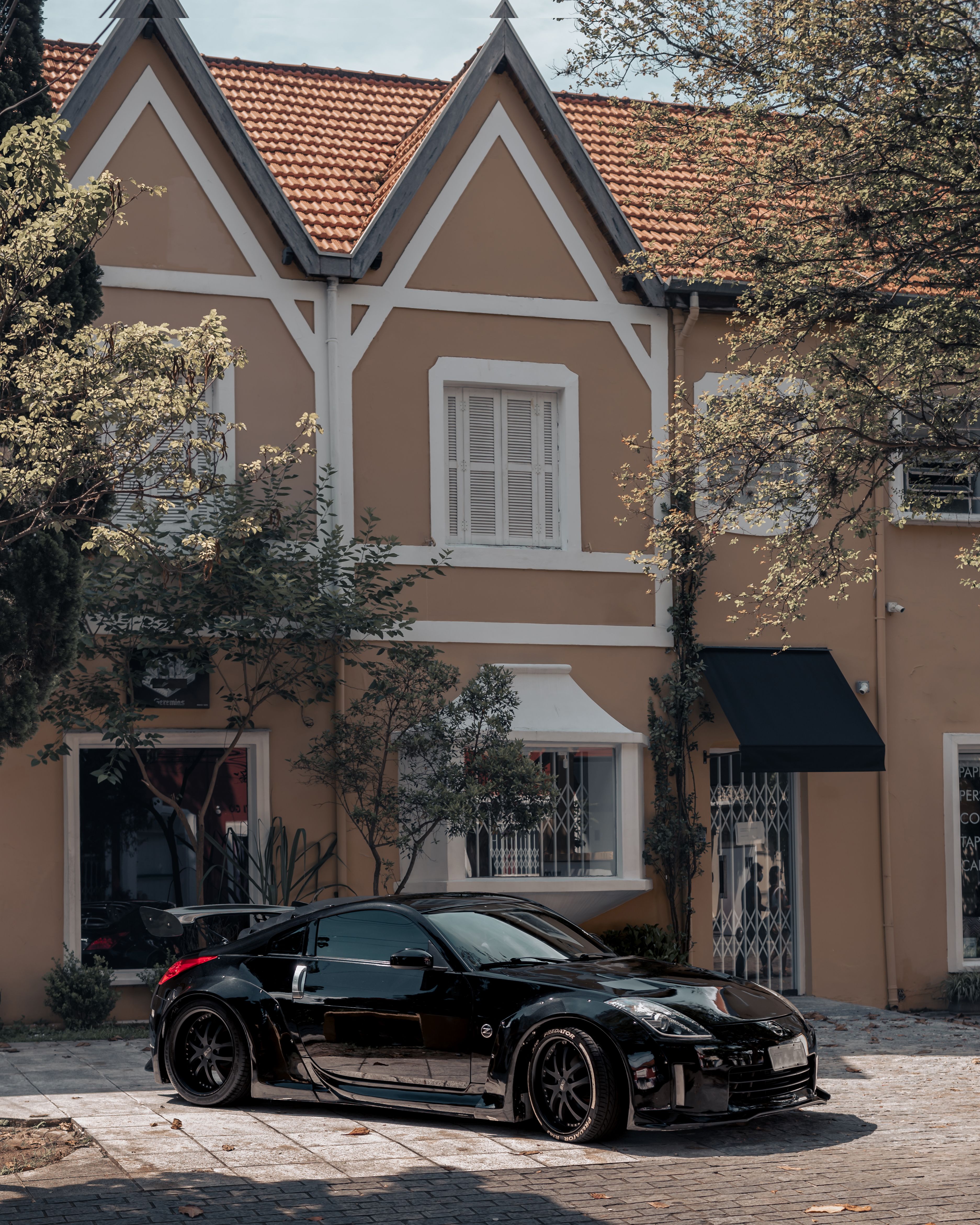 A Black Car Parked in Front of the House · Free Stock Photo