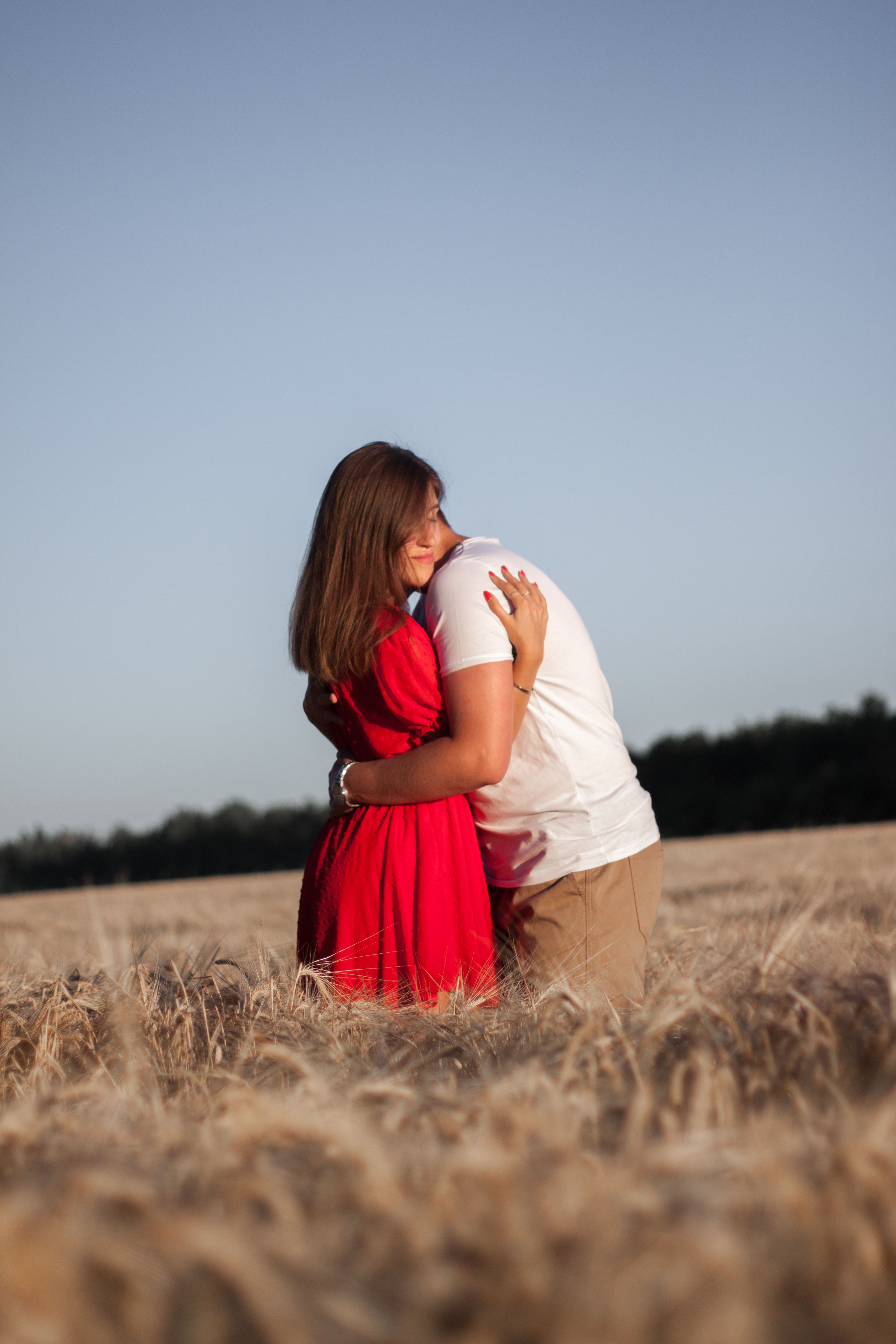 A Couple Hugging in a Field · Free Stock Photo