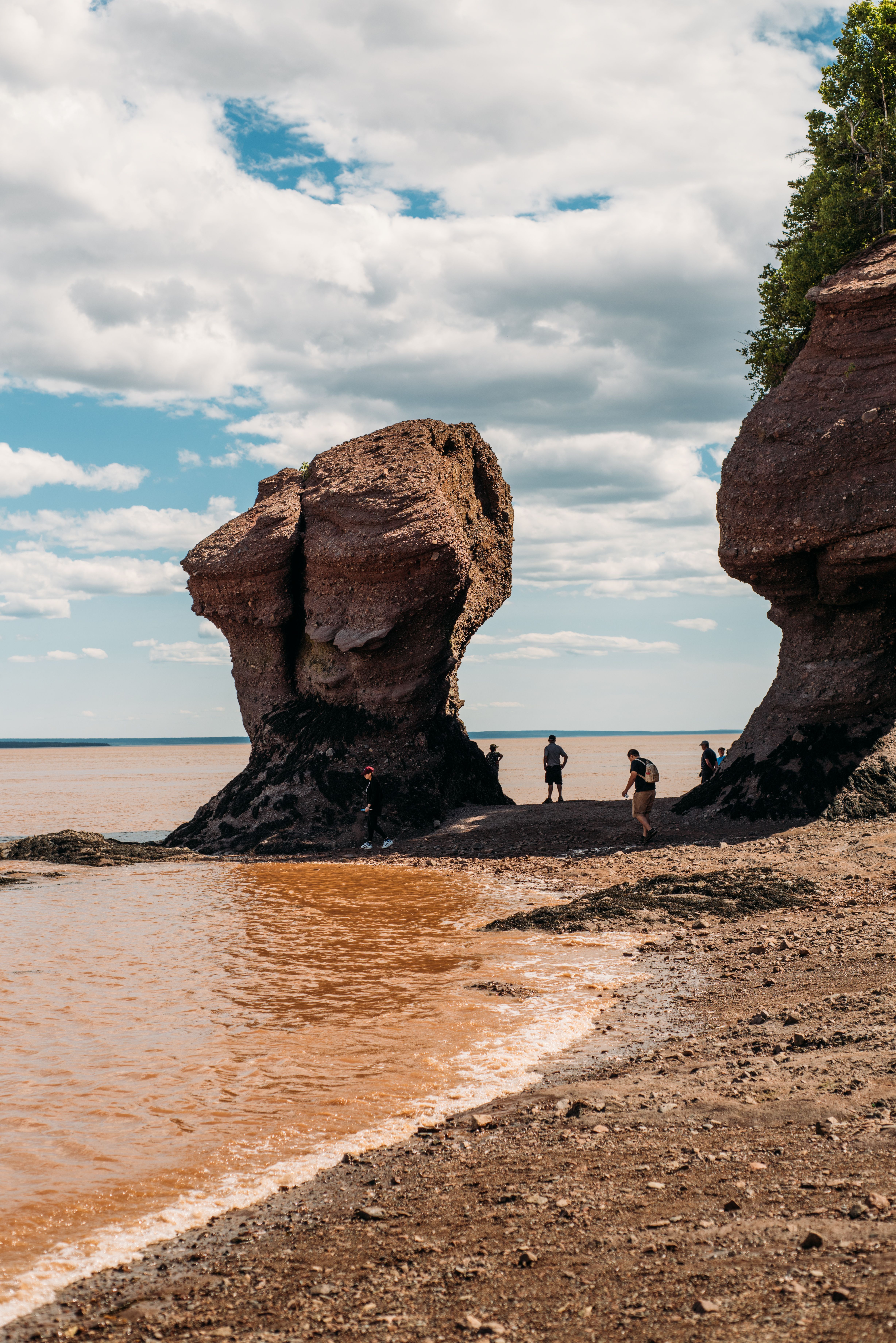 People Standing Between the Rock Formations · Free Stock Photo