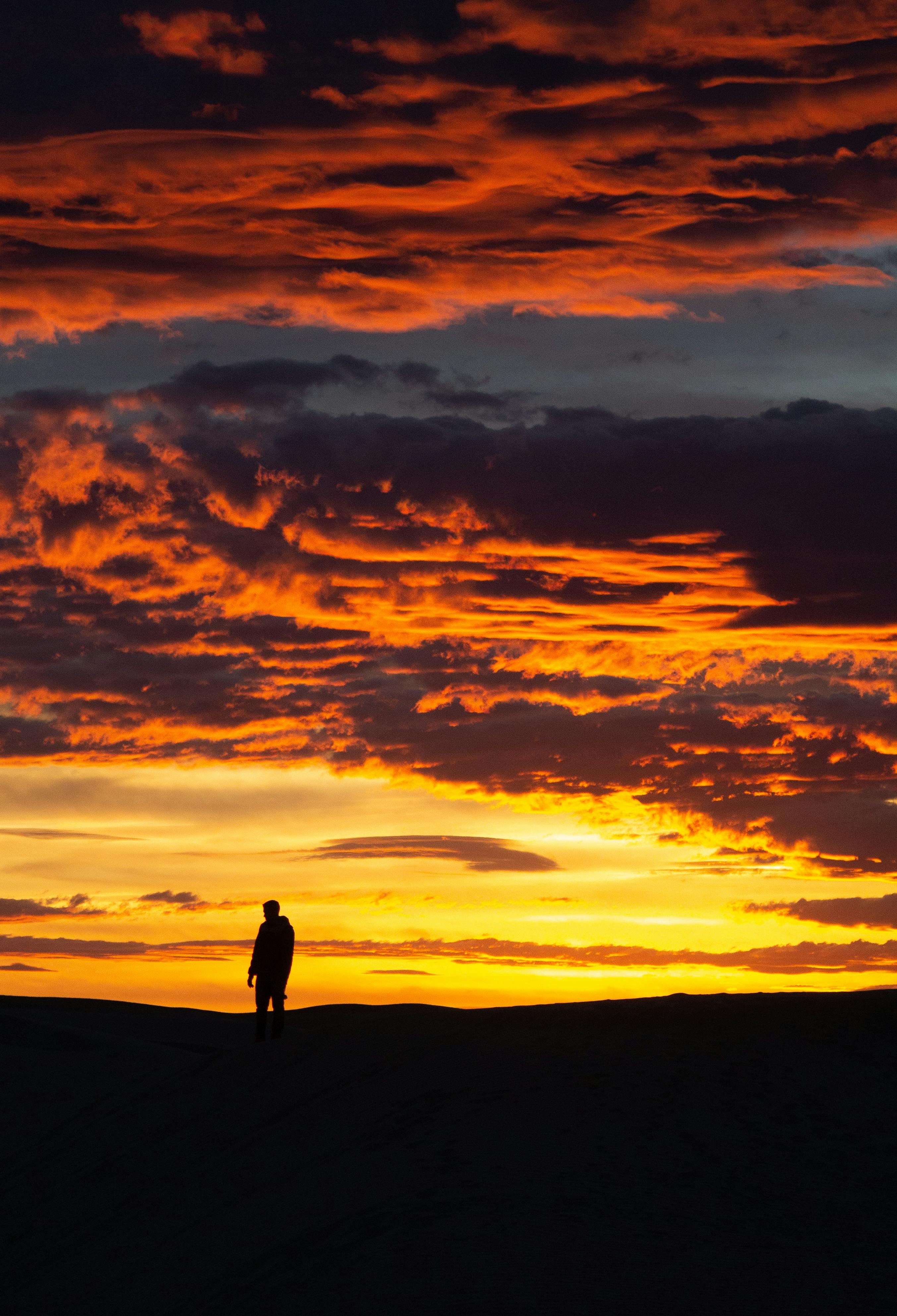 Person Standing in Distance Against Beautiful Vibrant Sunset · Free ...