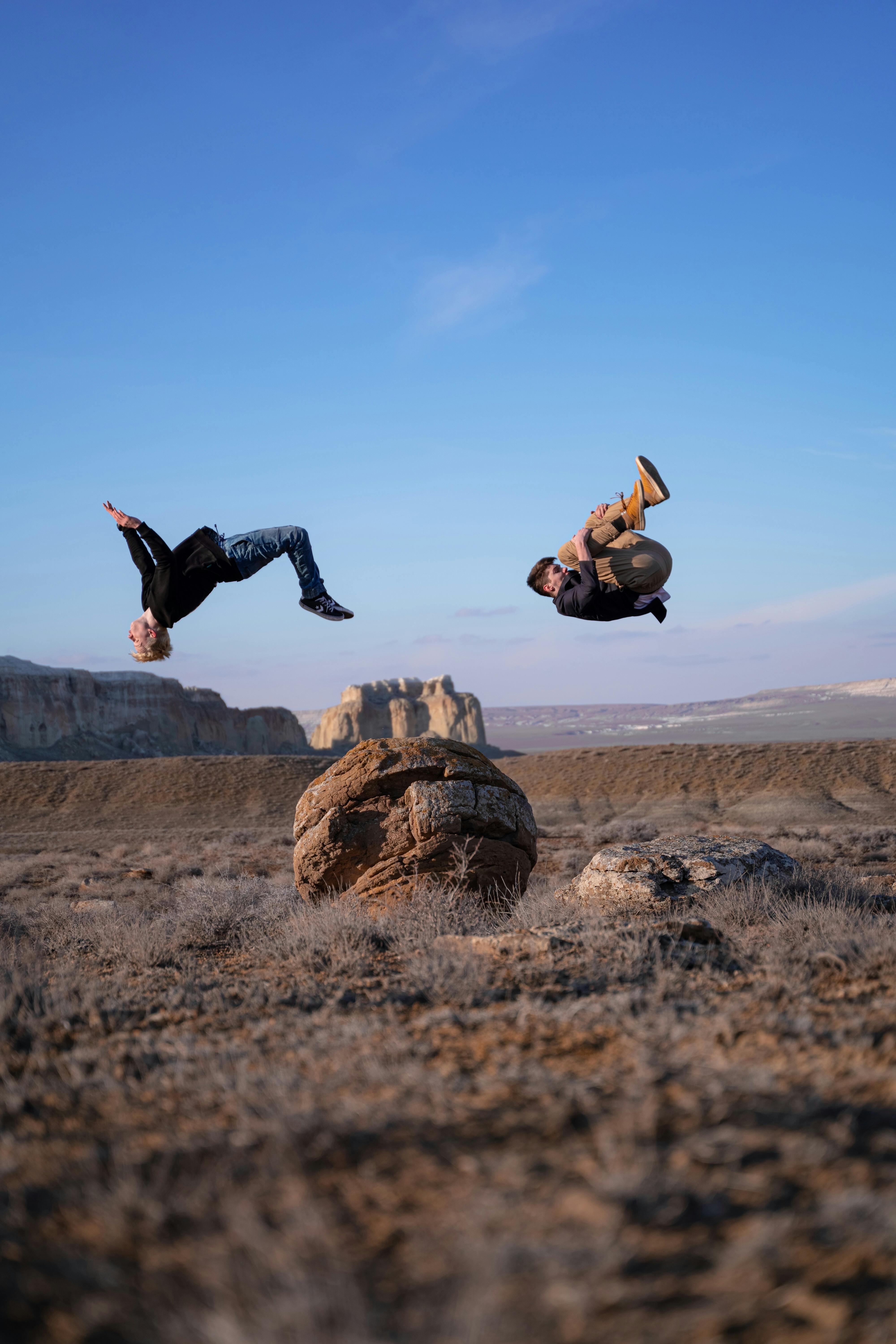 Young Men Doing Jump Shot on a Desert · Free Stock Photo