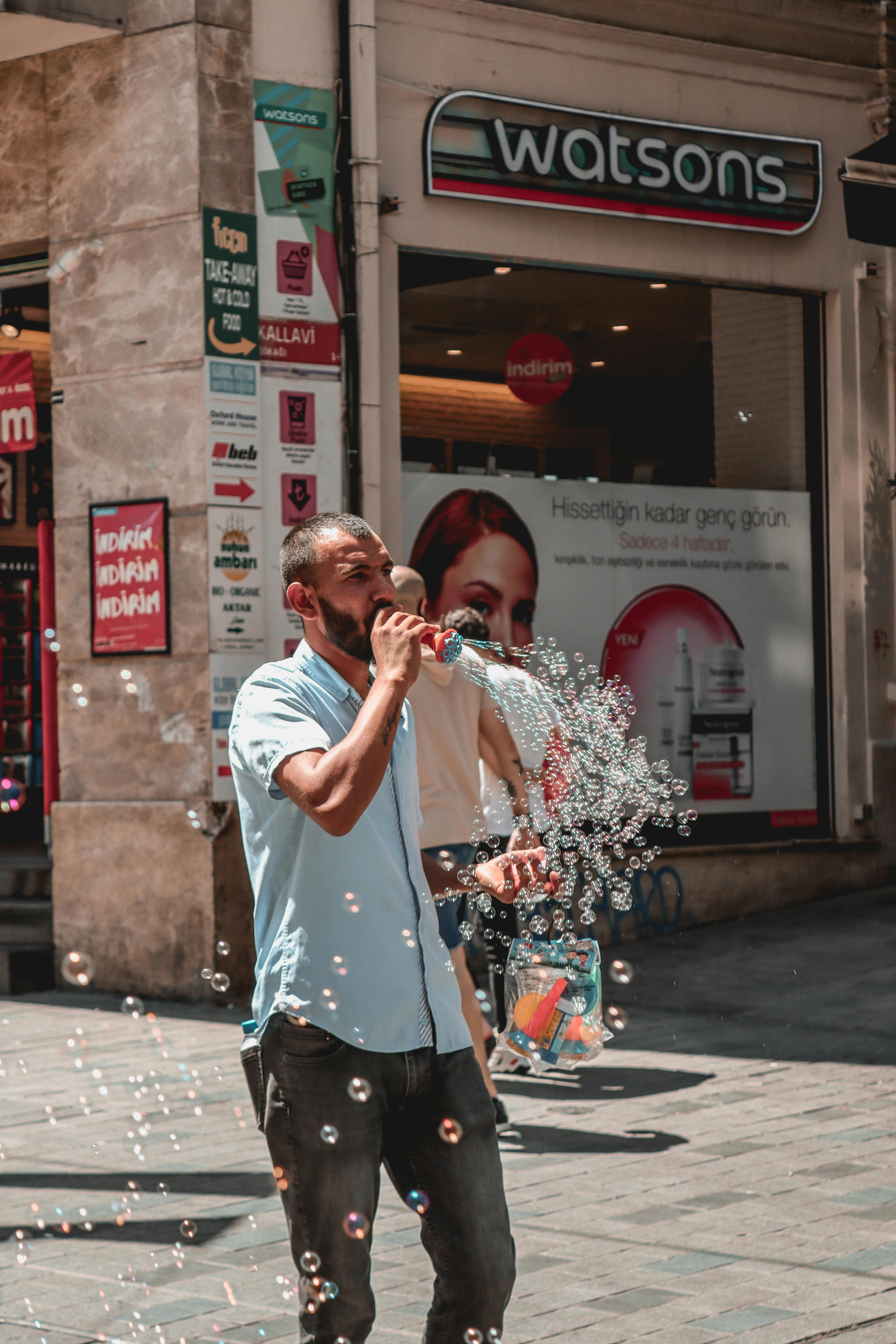 Man Blowing Bubbles on the Street · Free Stock Photo