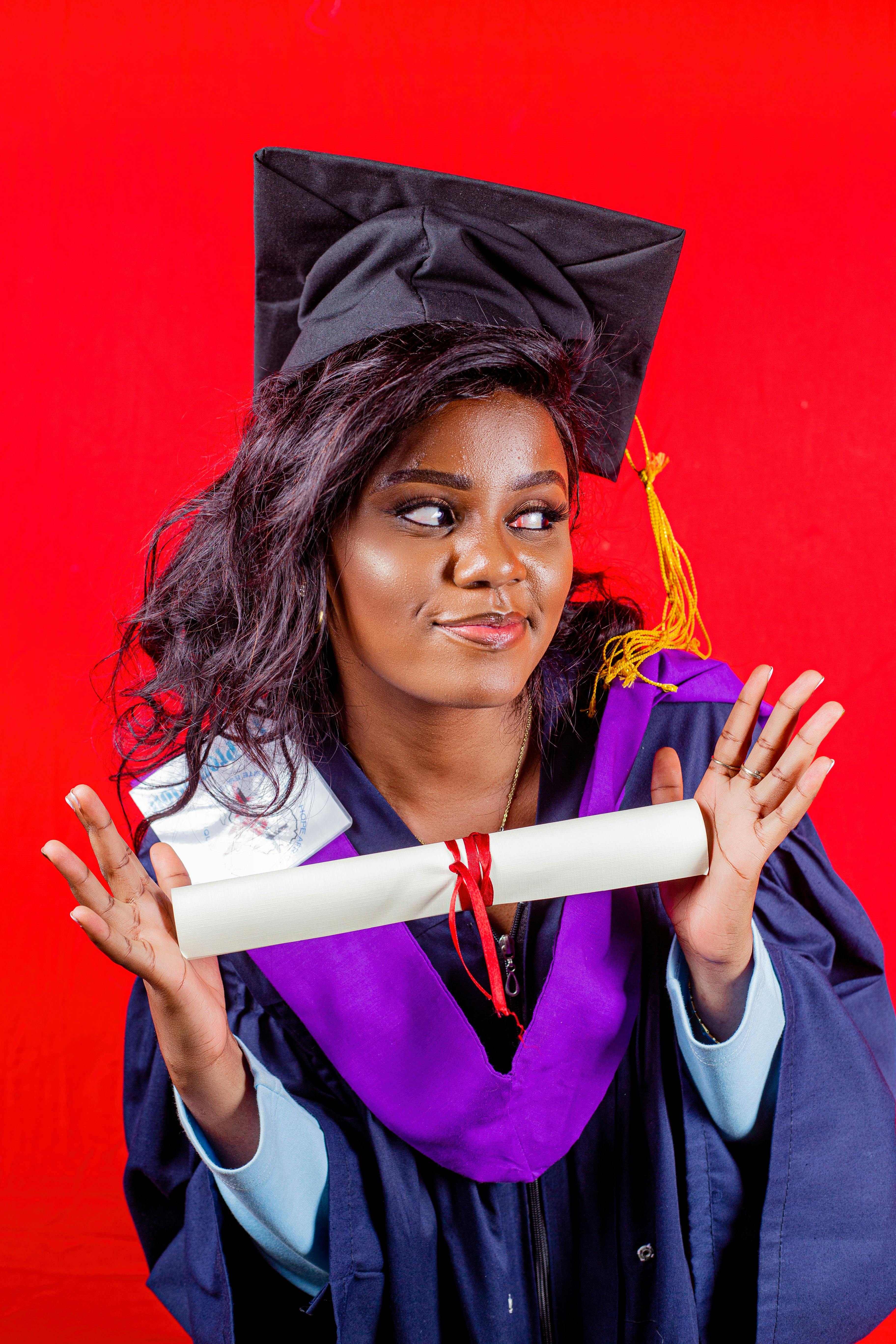 A Person Holding a Black Graduation Hat · Free Stock Photo