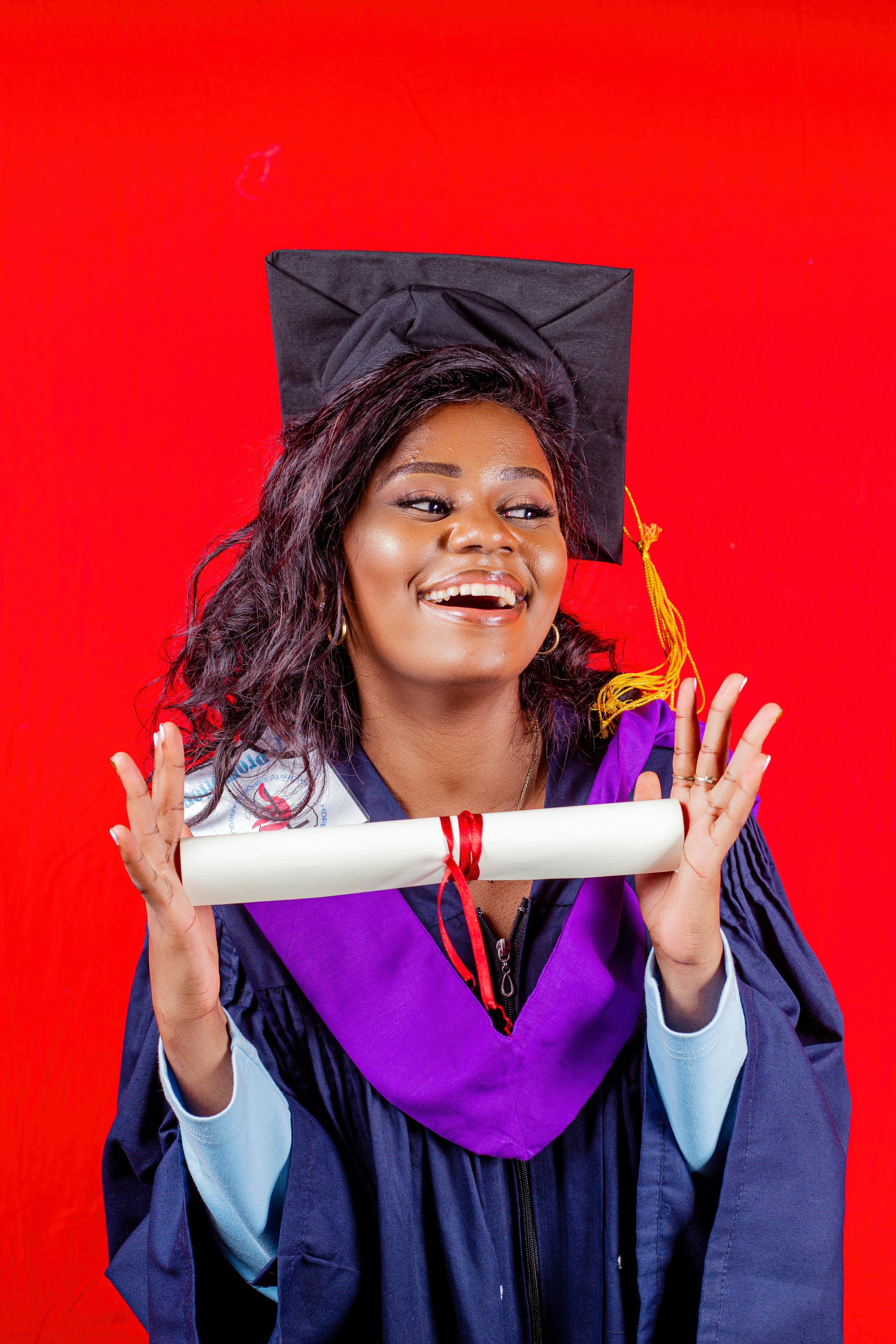 A Happy Woman Posing with a Diploma · Free Stock Photo