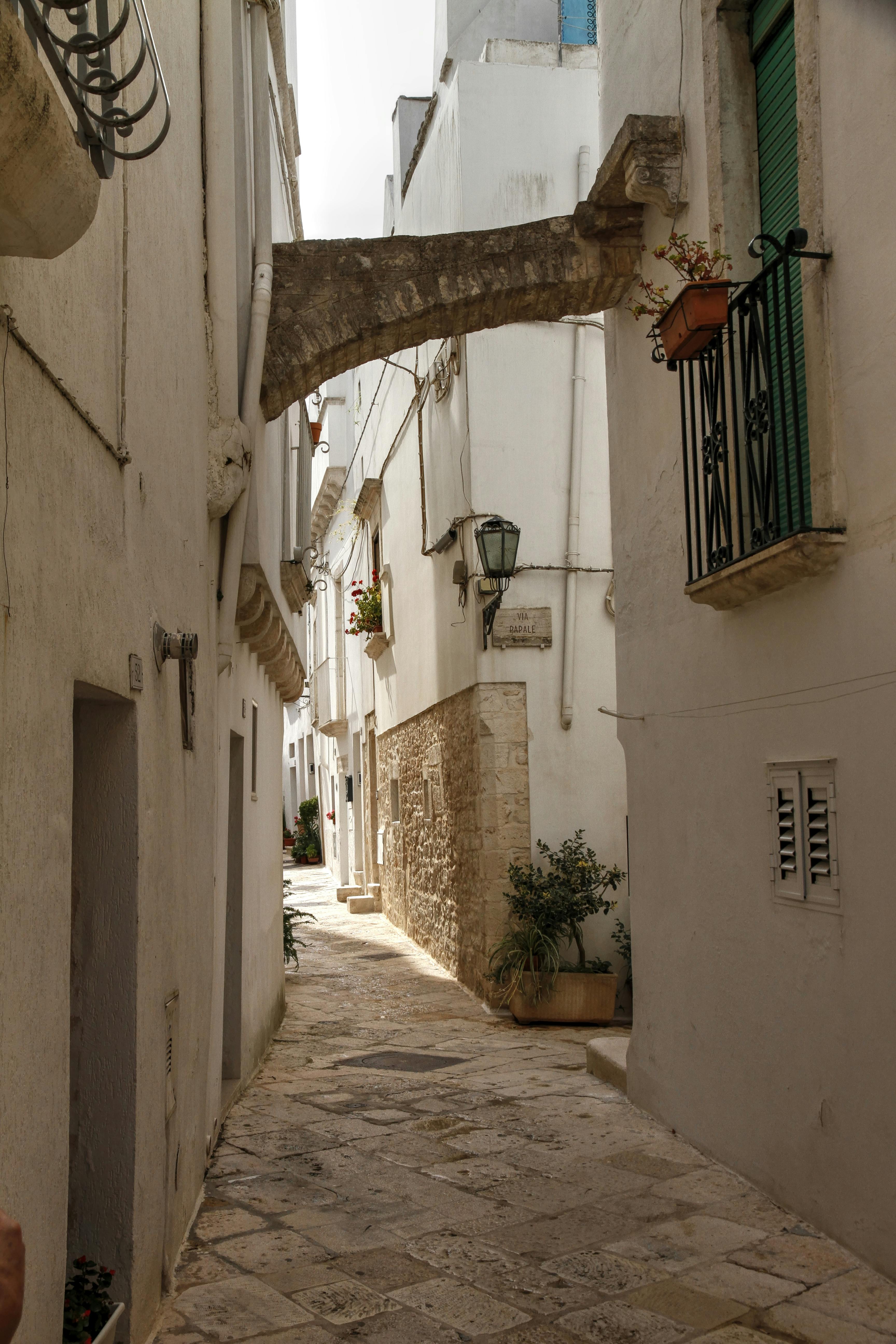 Stone Paved Alley in Between Concrete Building · Free Stock Photo