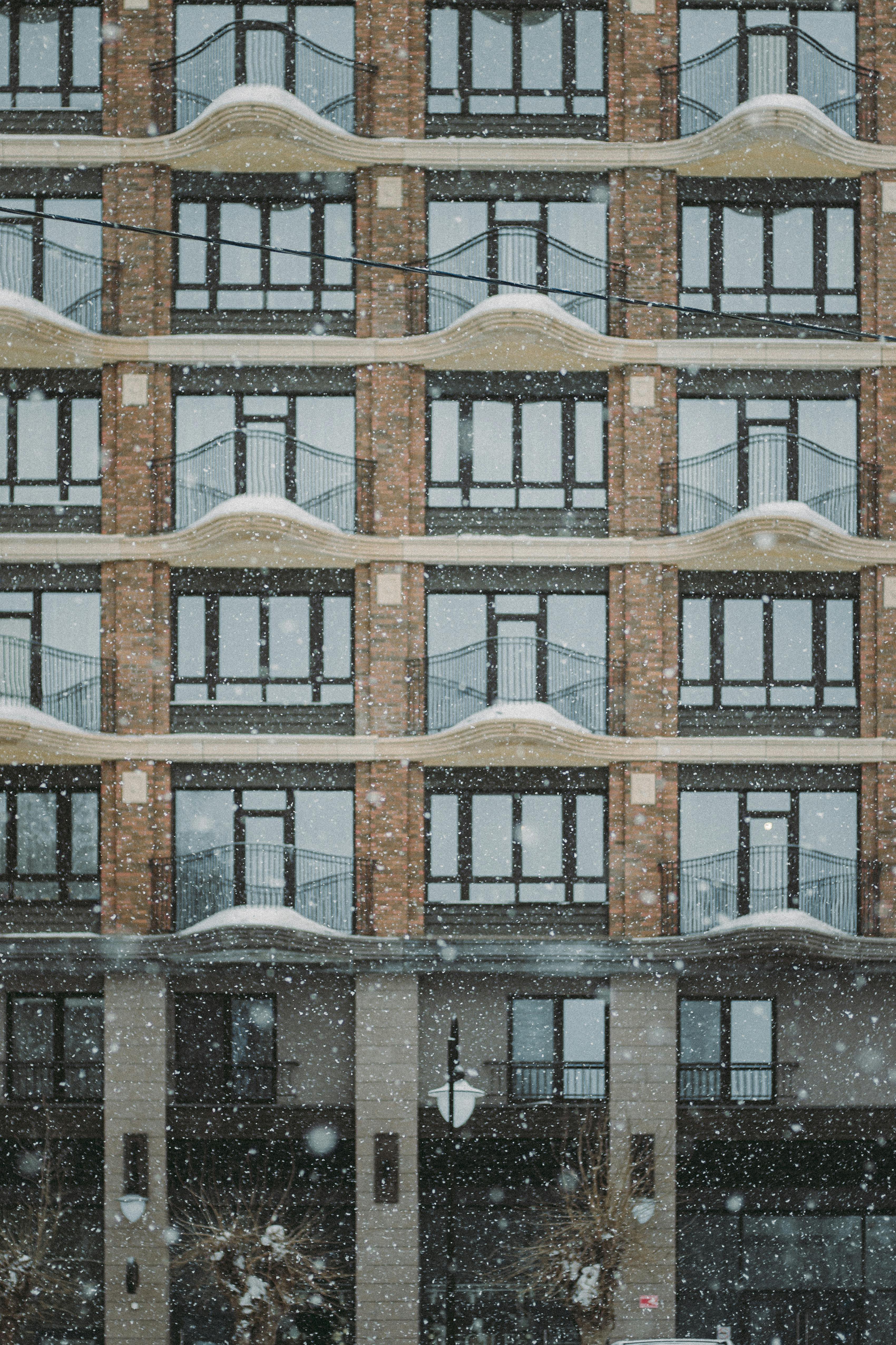 Facade of Residential Building during Snowstorm · Free Stock Photo