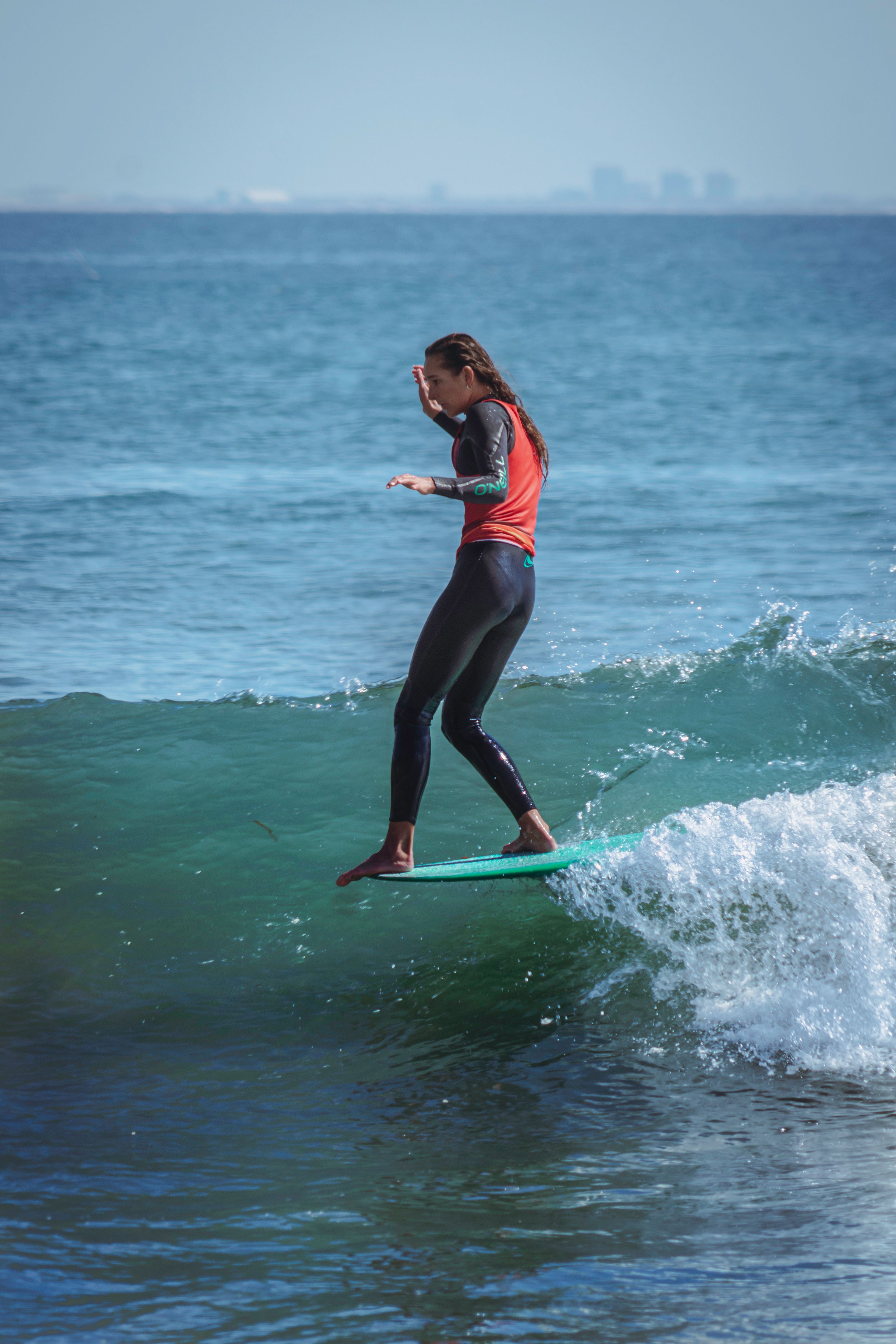 A Woman Surfing on the Blue Sea · Free Stock Photo