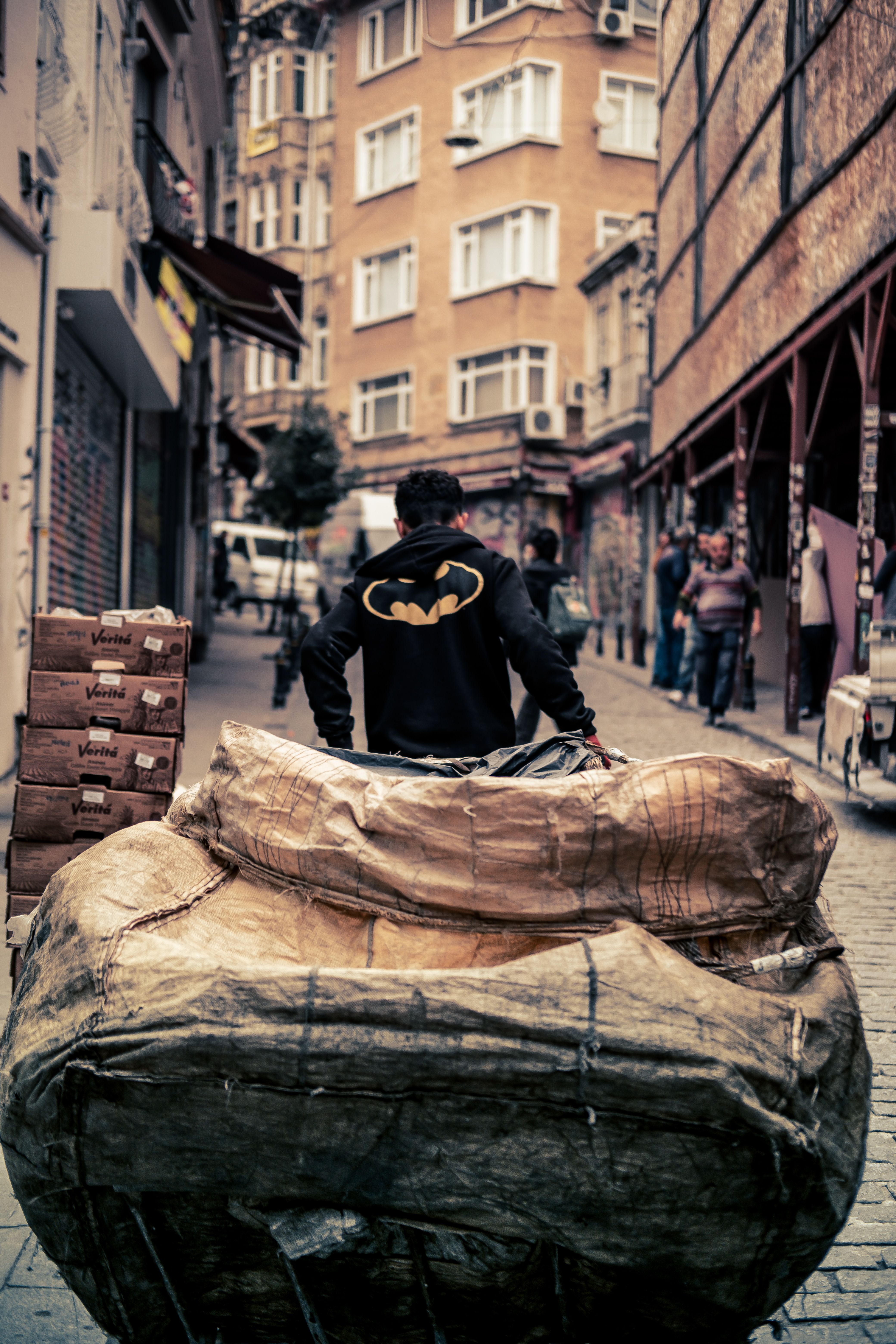 Man Towing Cart with Bag in City · Free Stock Photo