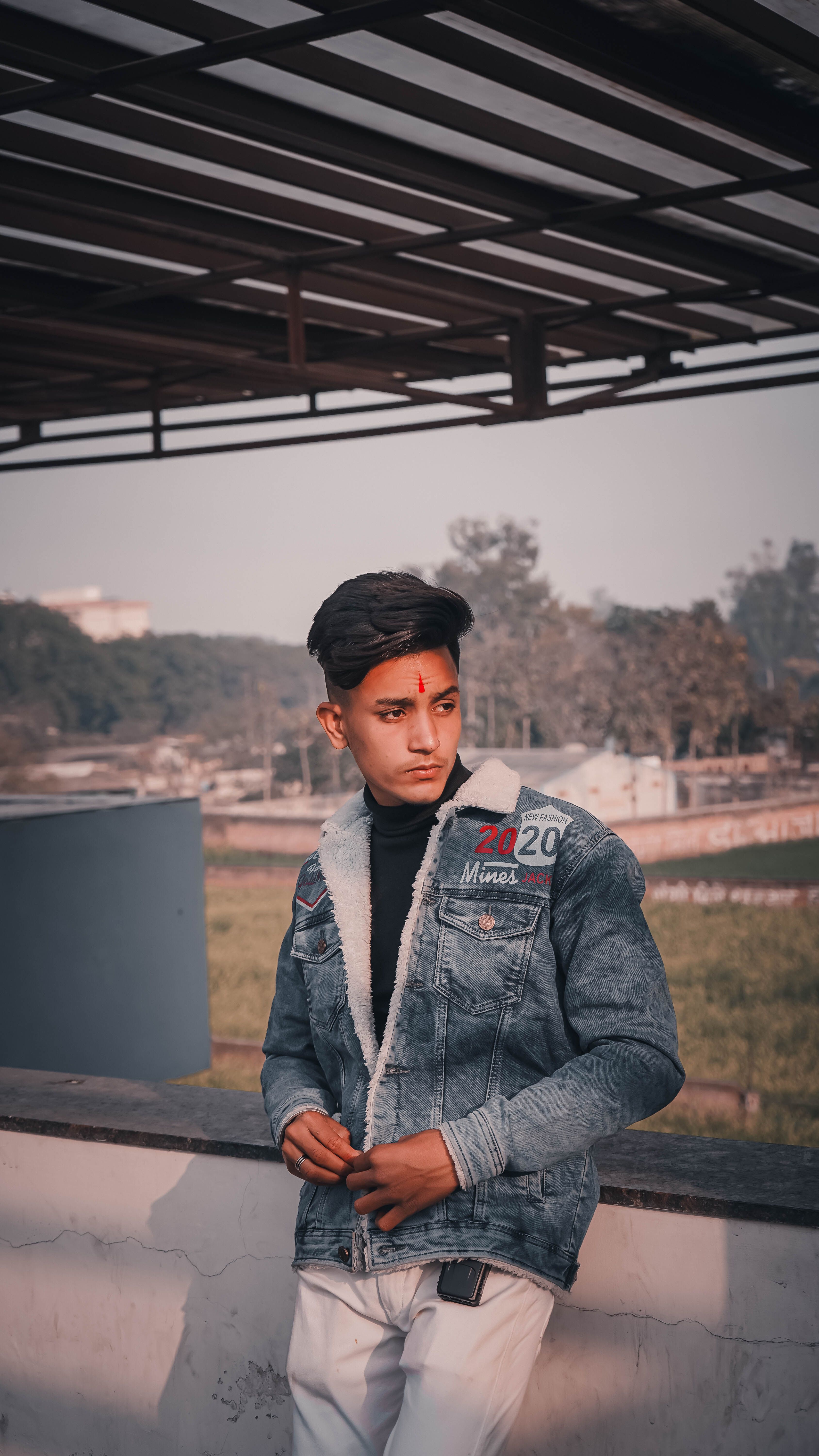 Man in Gray Hoodie Standing Against a Wall · Free Stock Photo