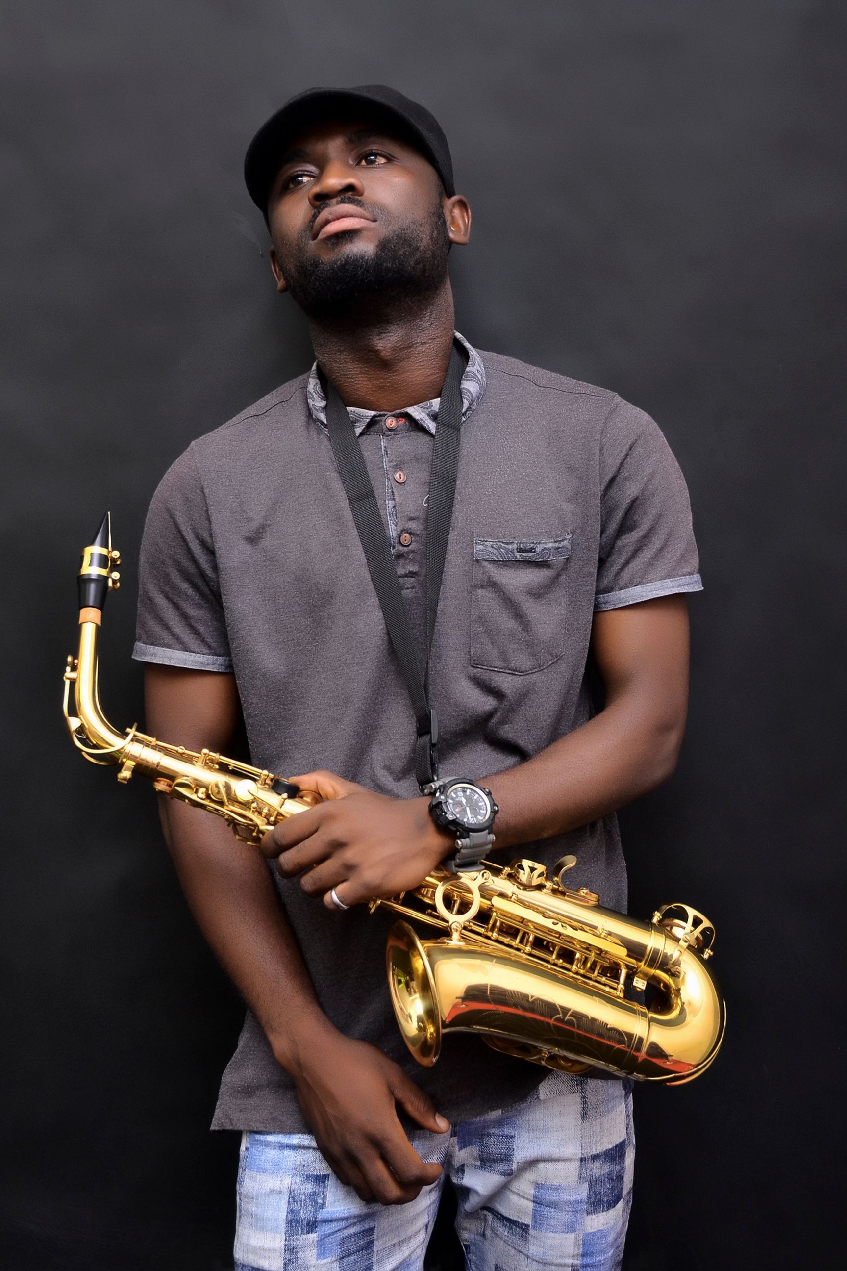 Man Holding a Saxophone · Free Stock Photo