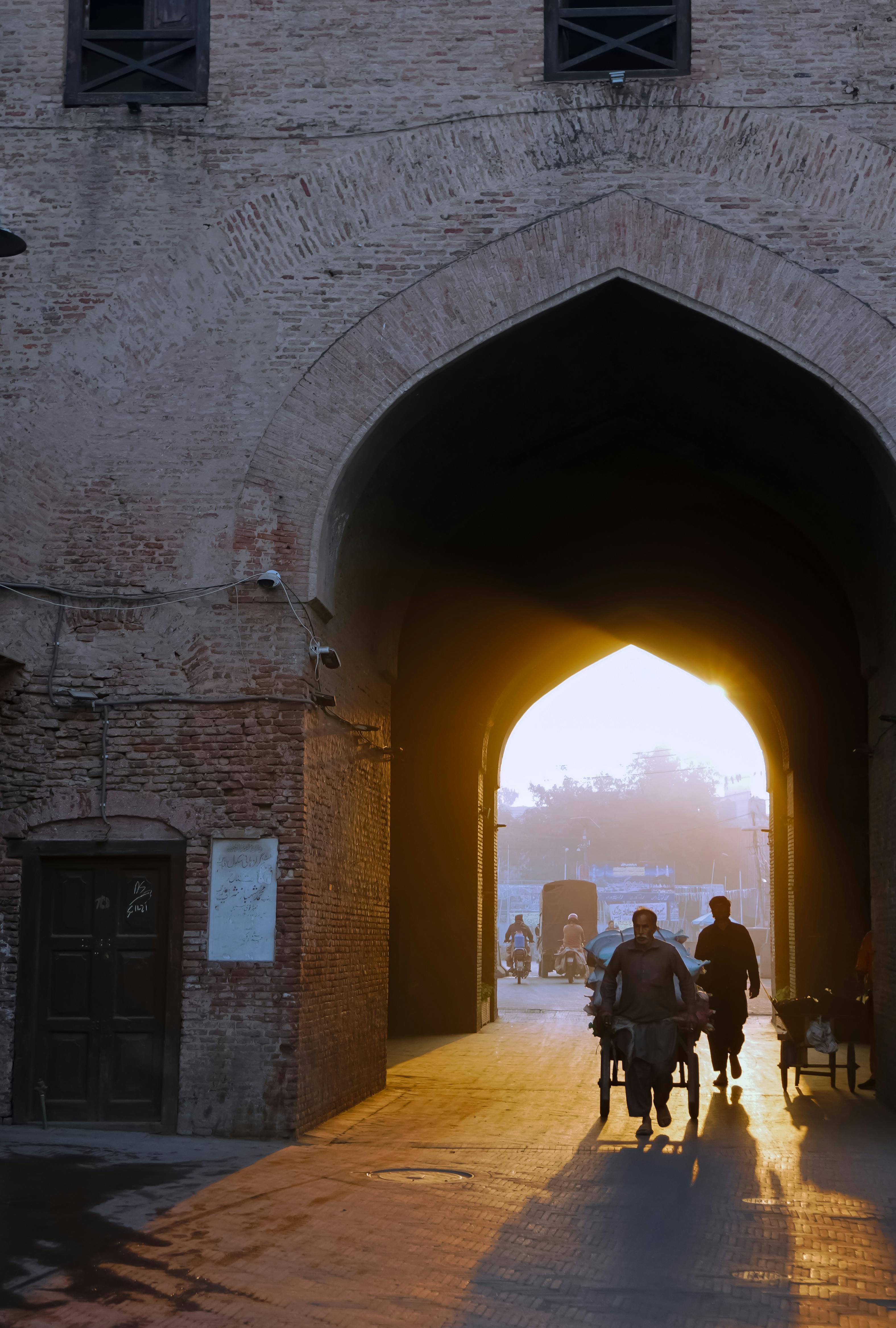 People Walking through Town Gate · Free Stock Photo