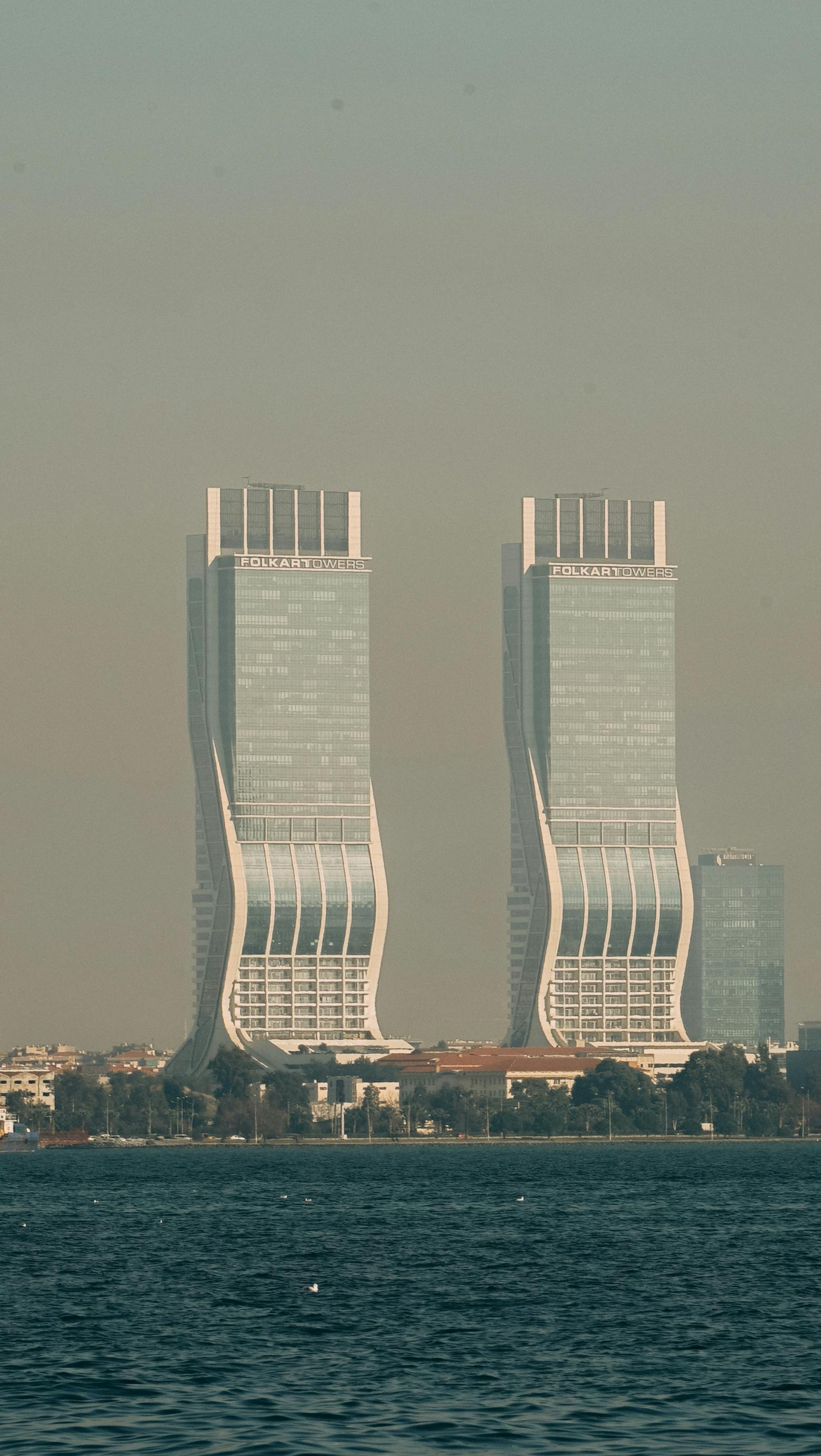 An Asphalt Road Between High Rise Buildings and a Beach · Free Stock Photo