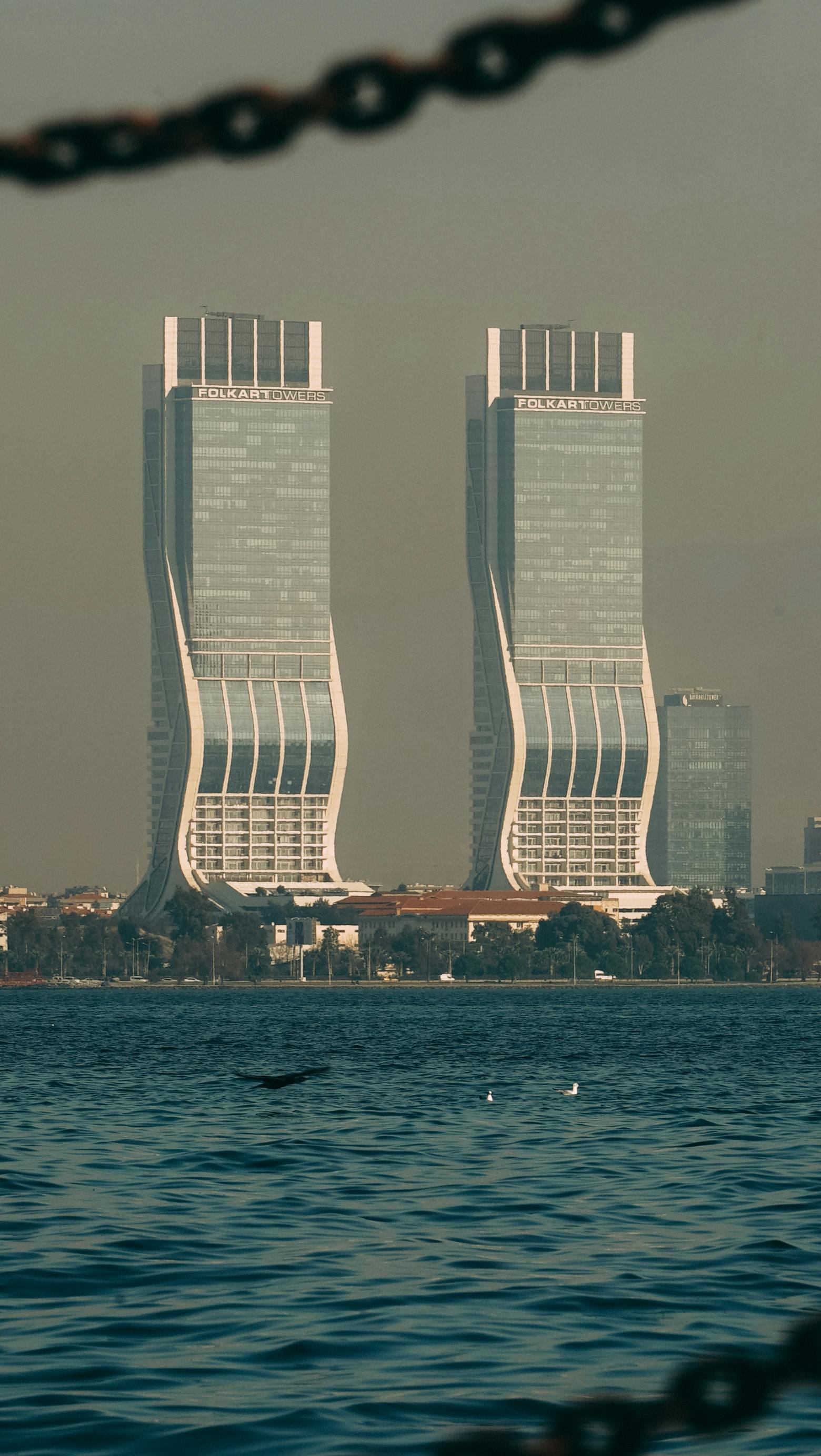 An Asphalt Road Between High Rise Buildings and a Beach · Free Stock Photo