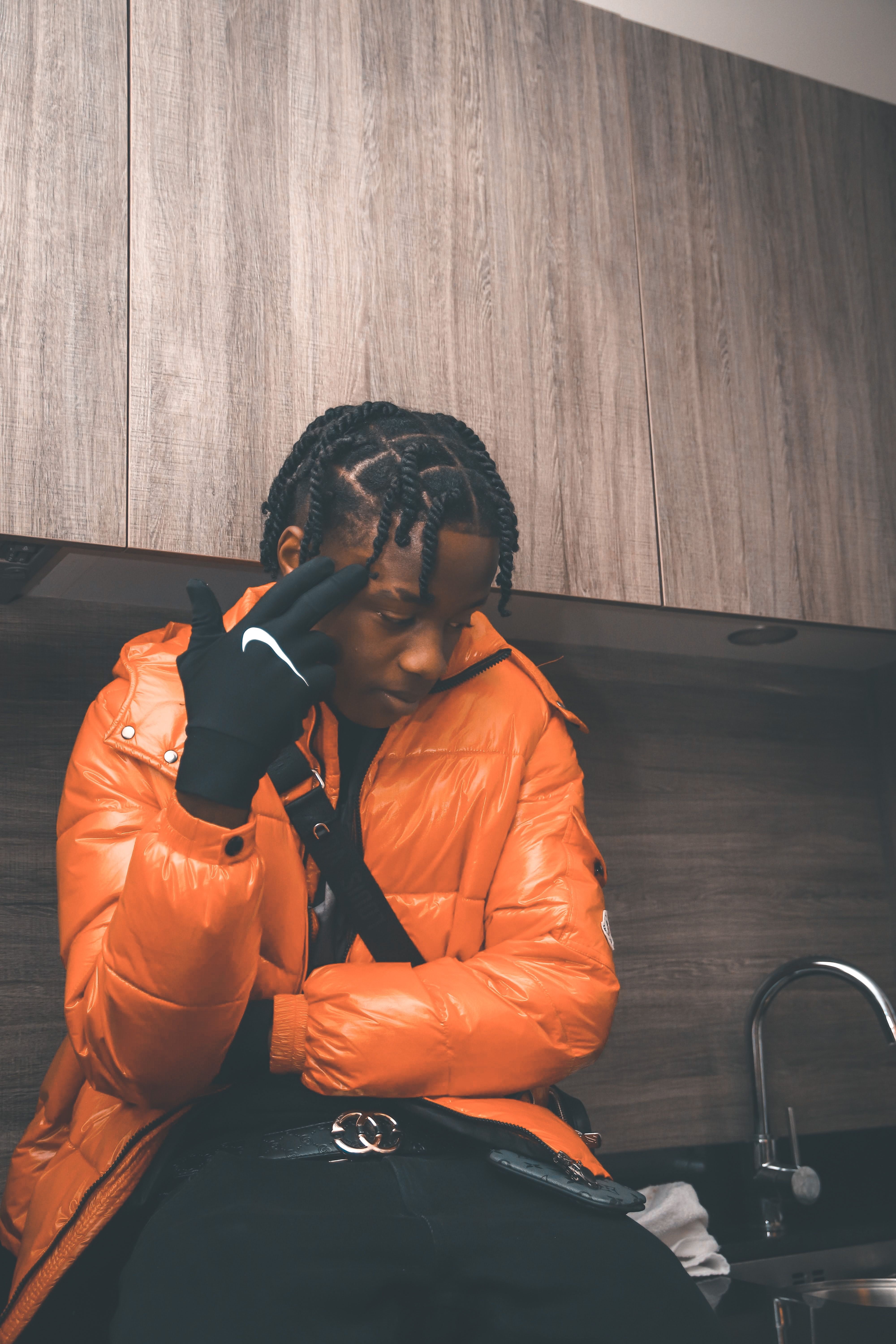 Man in Orange Jacket Wearing Black Sunglasses · Free Stock Photo
