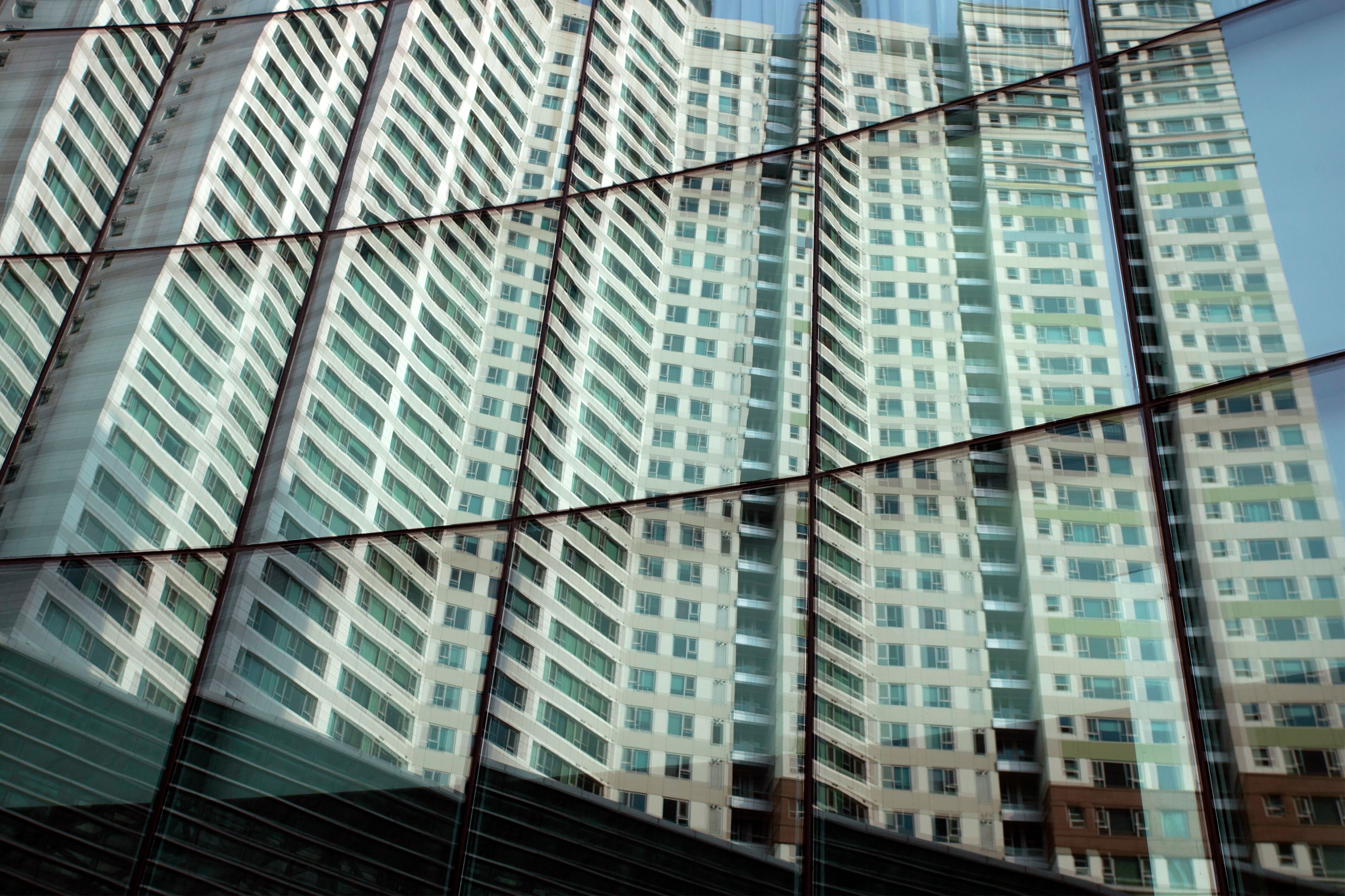 A Reflection of a Building on Glass Panels · Free Stock Photo
