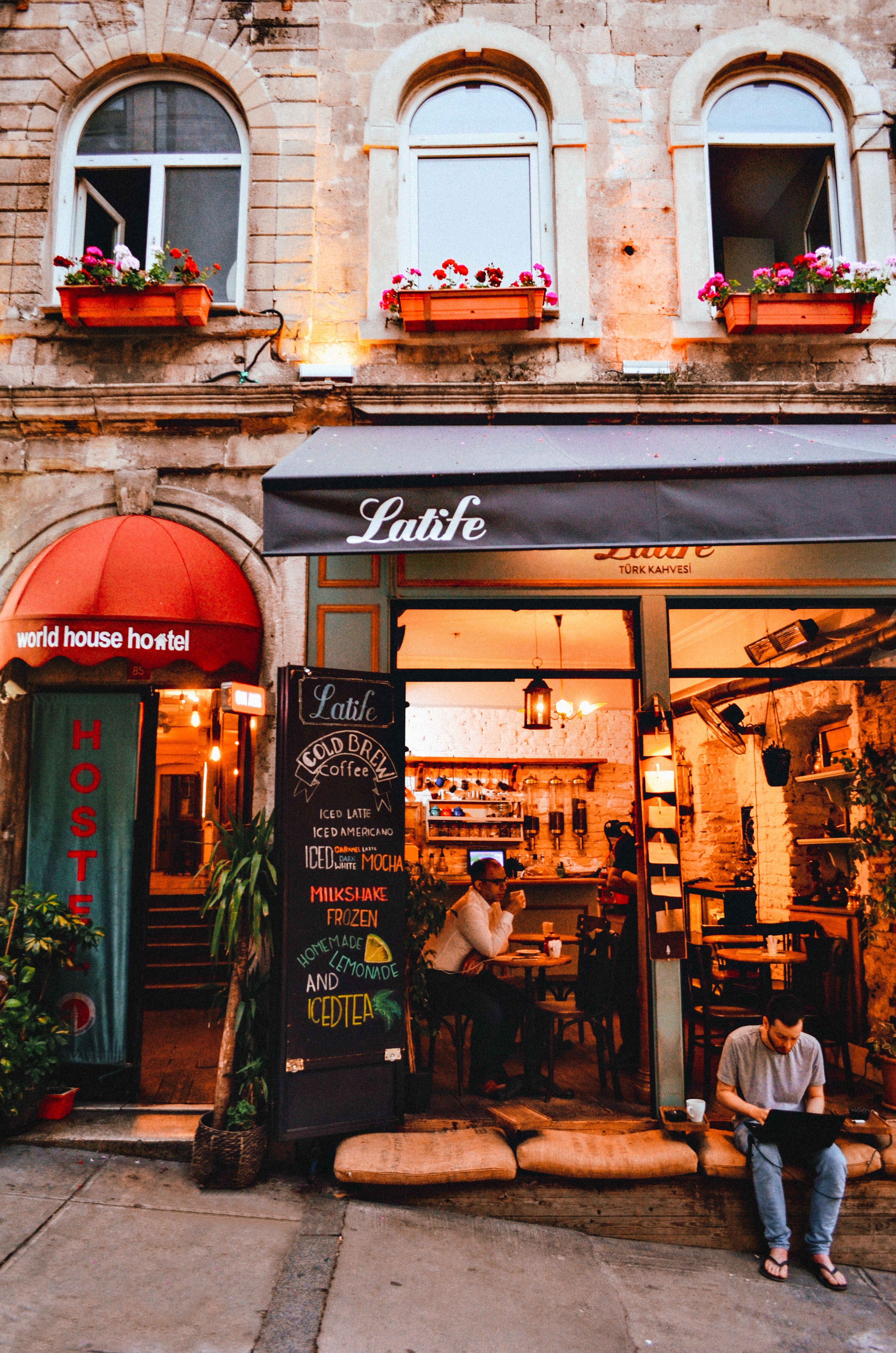 City Street with an Illuminated Cafe · Free Stock Photo