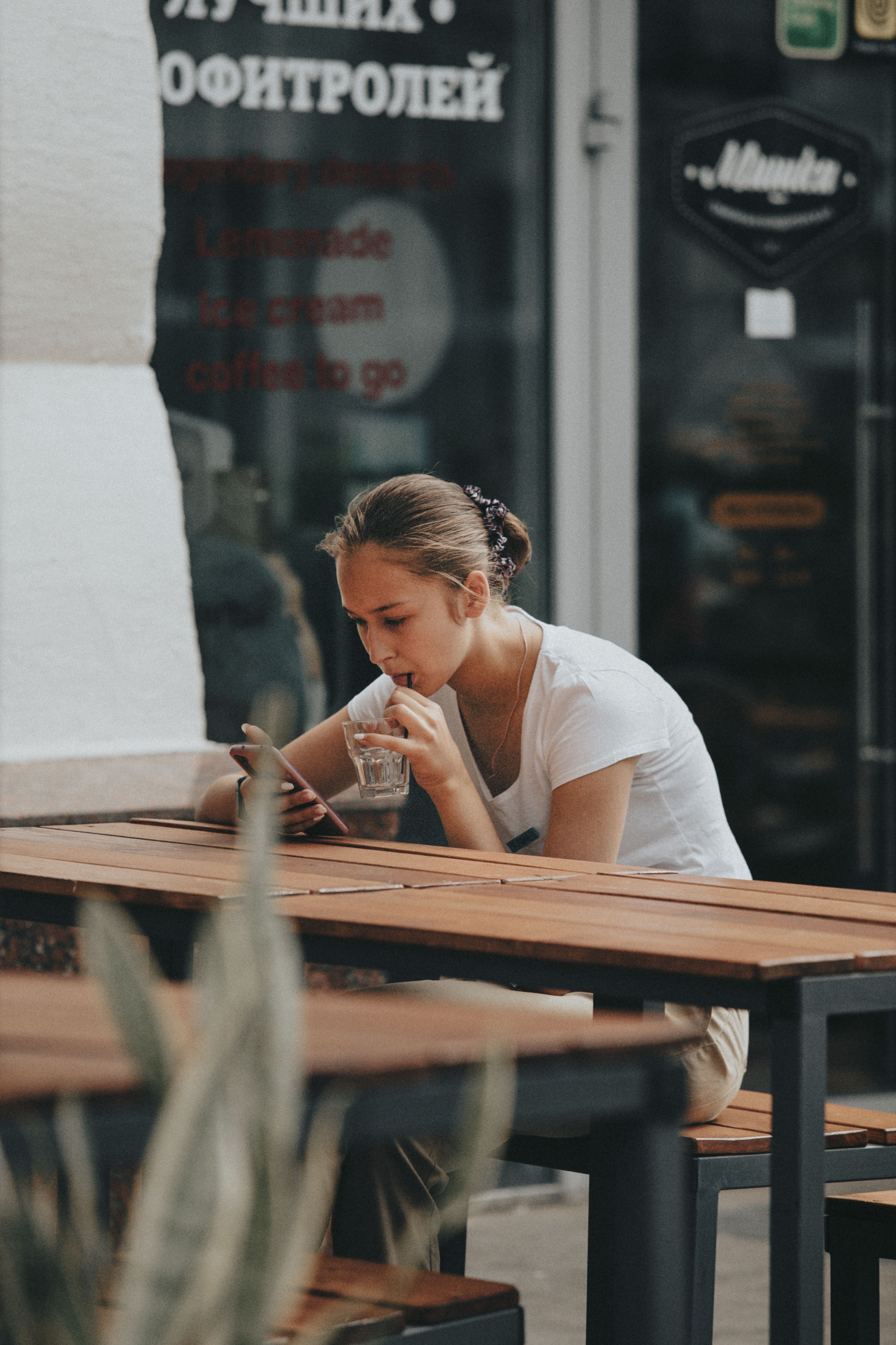 Woman Using Smartphone and Drinking Beverage · Free Stock Photo