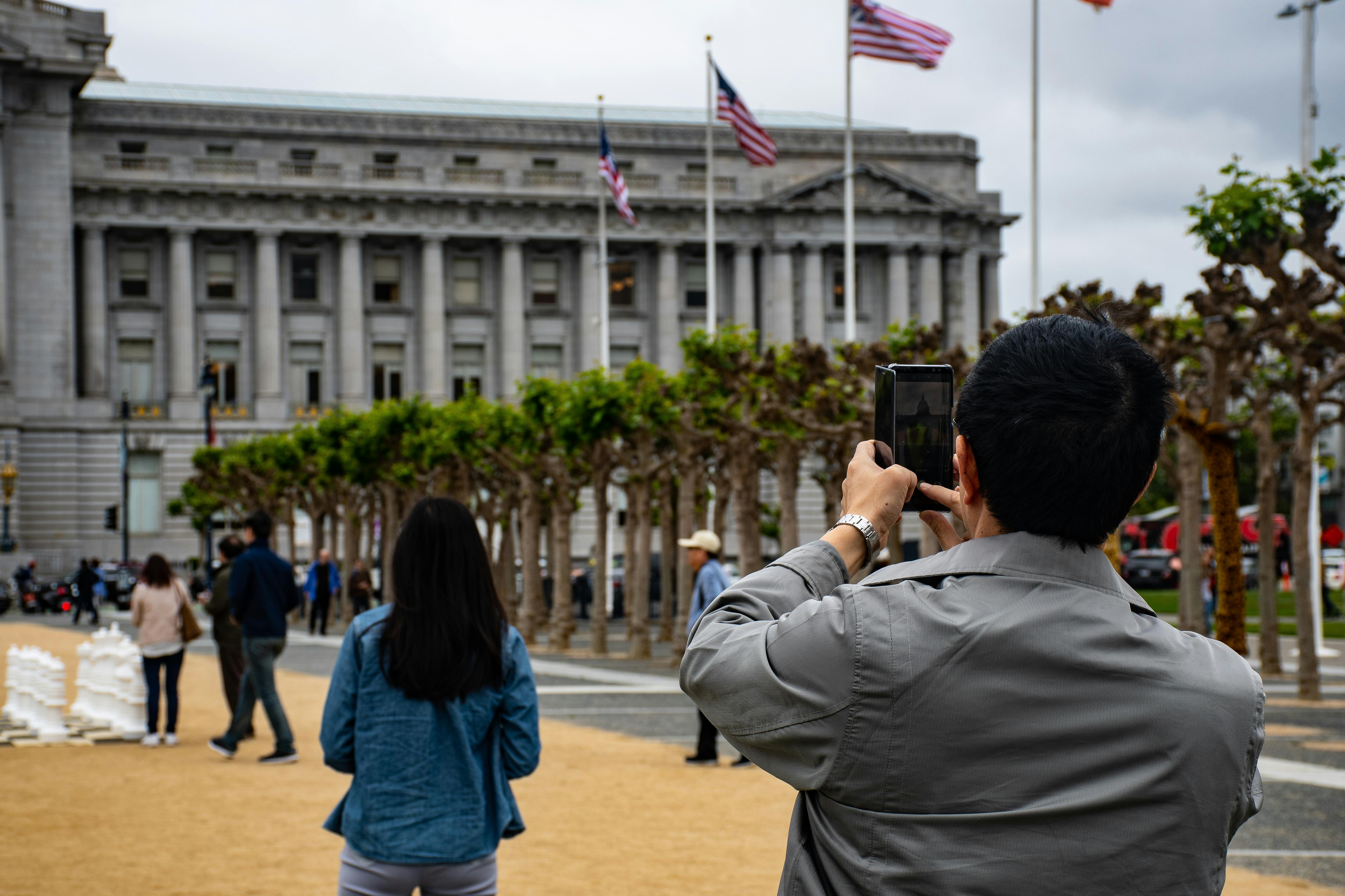 Man Using Smartphone to Capture Photo · Free Stock Photo