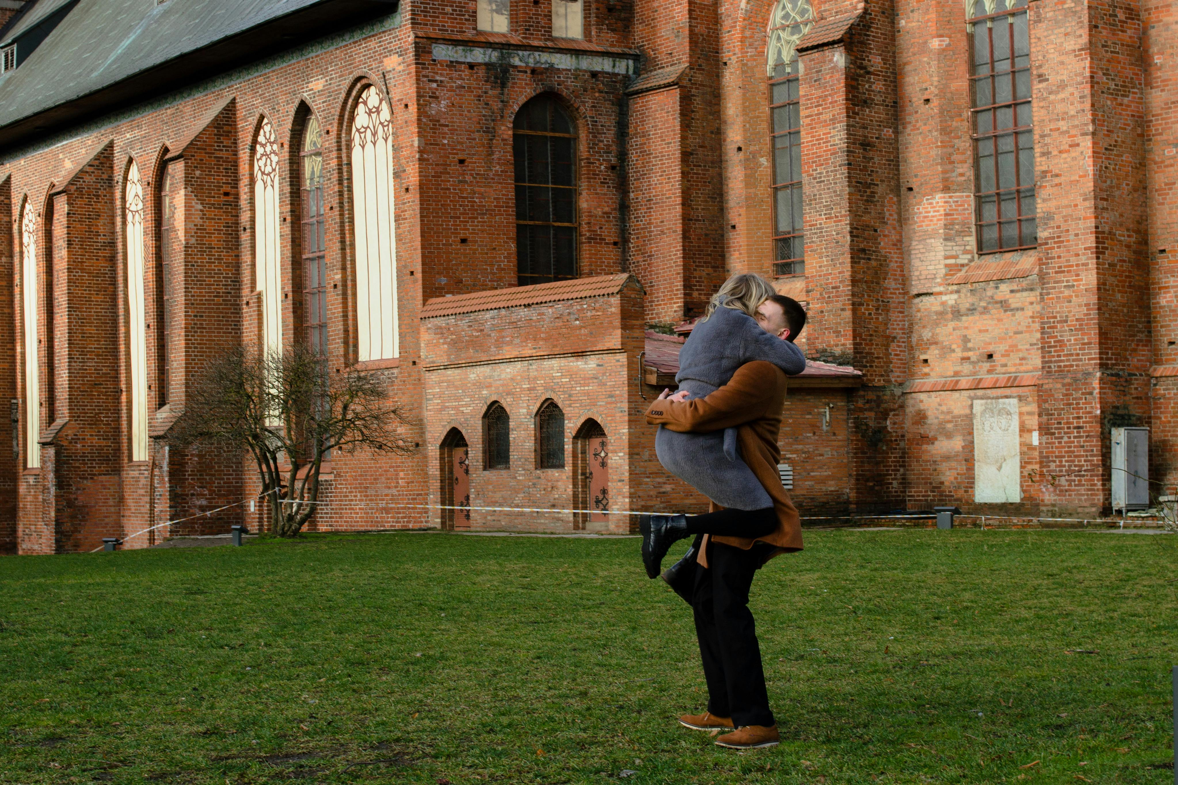 A Couple Hugging on the Grass Field · Free Stock Photo