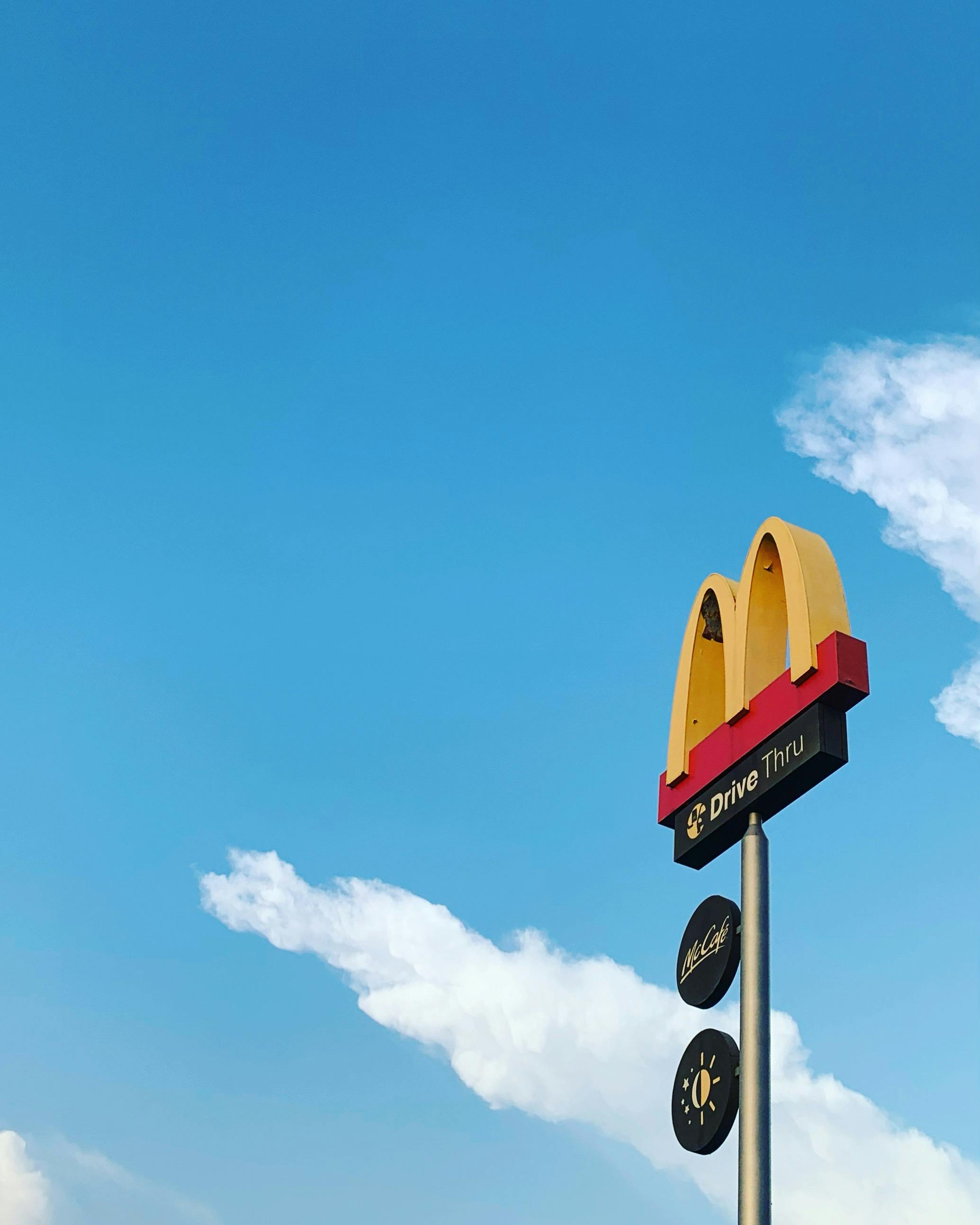 McDonalds Pole Sign Against Blue Sky · Free Stock Photo