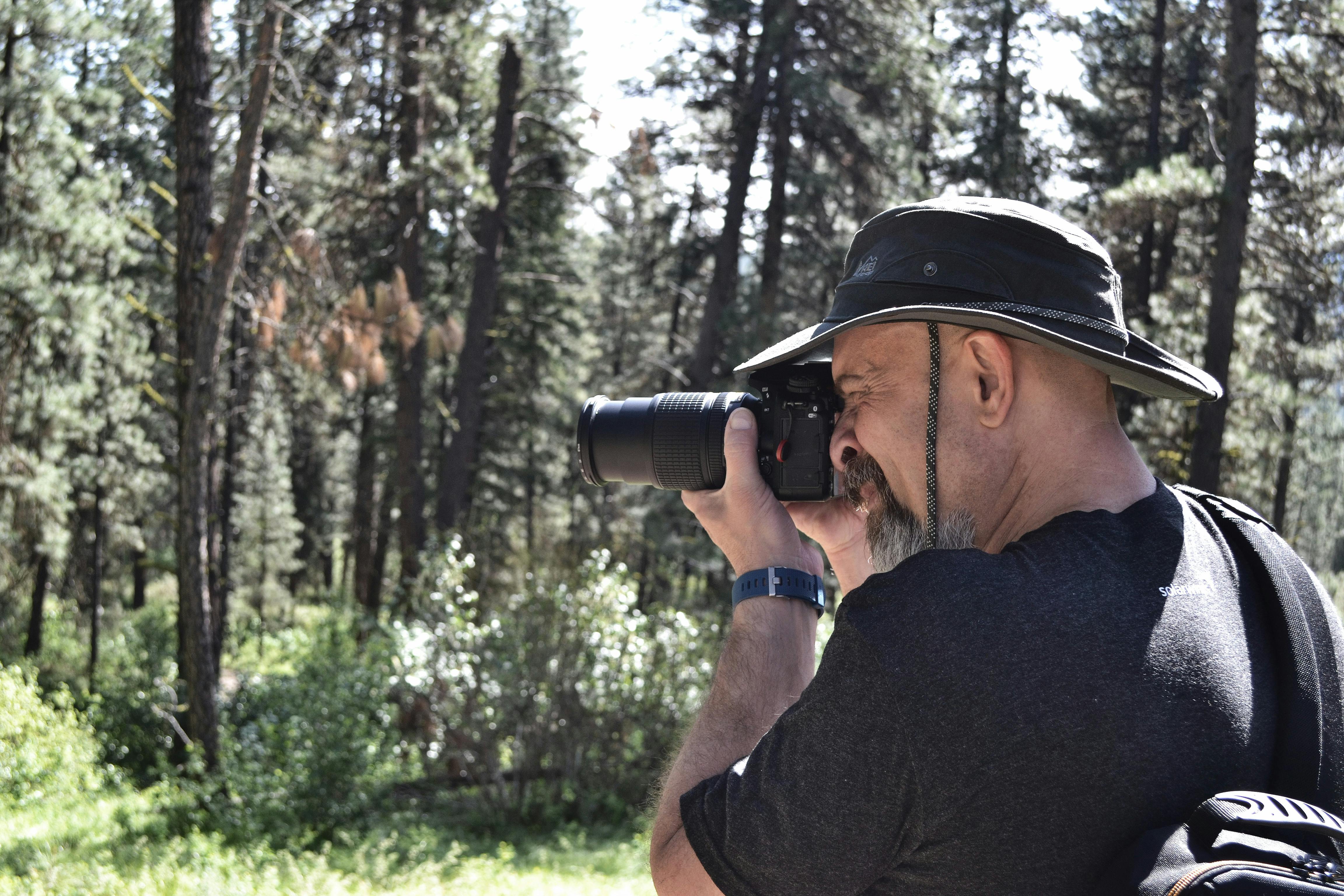 Man Taking Photo in Near Woods · Free Stock Photo