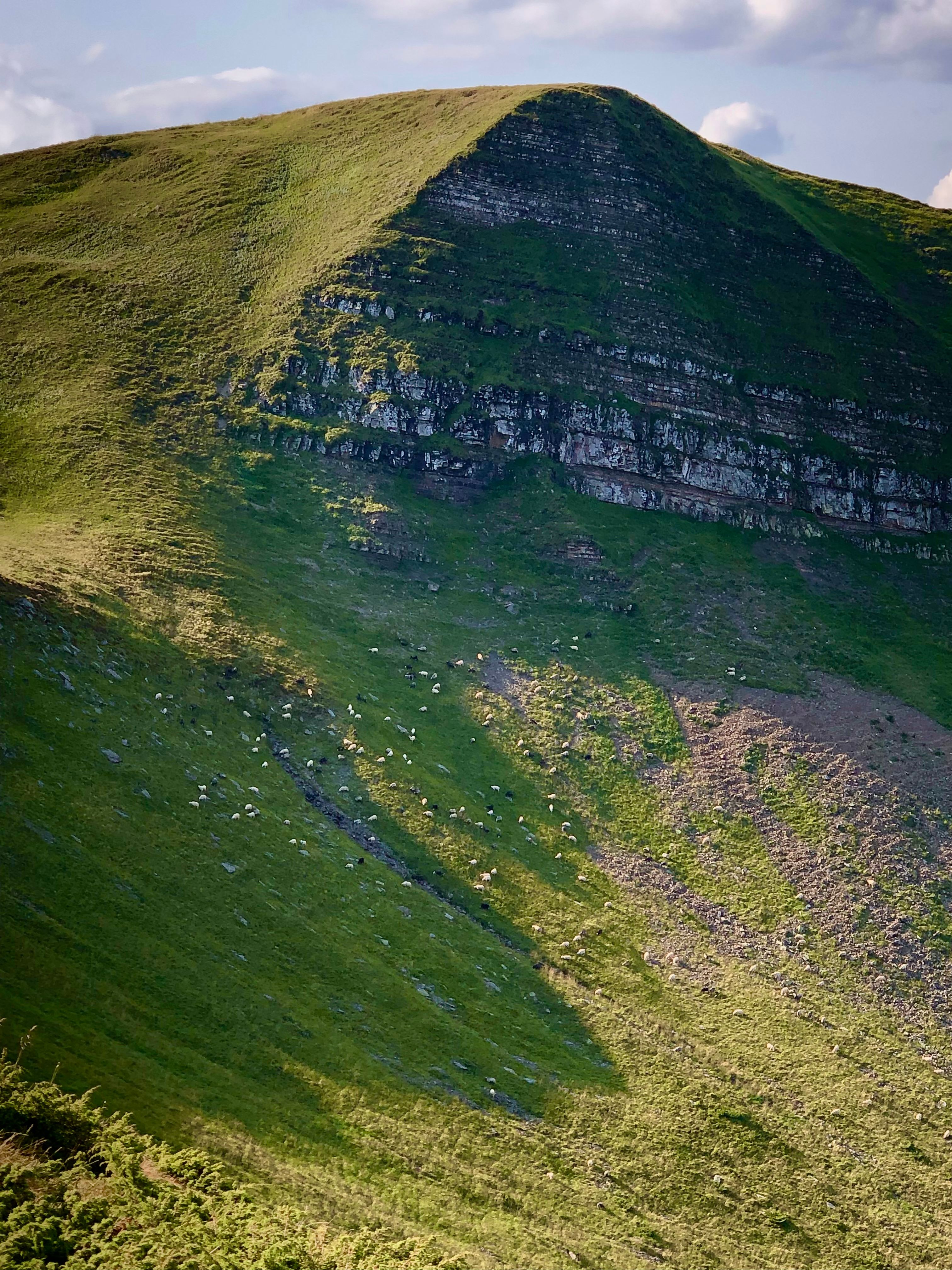Photo of Gray Grass Field Across Hill · Free Stock Photo