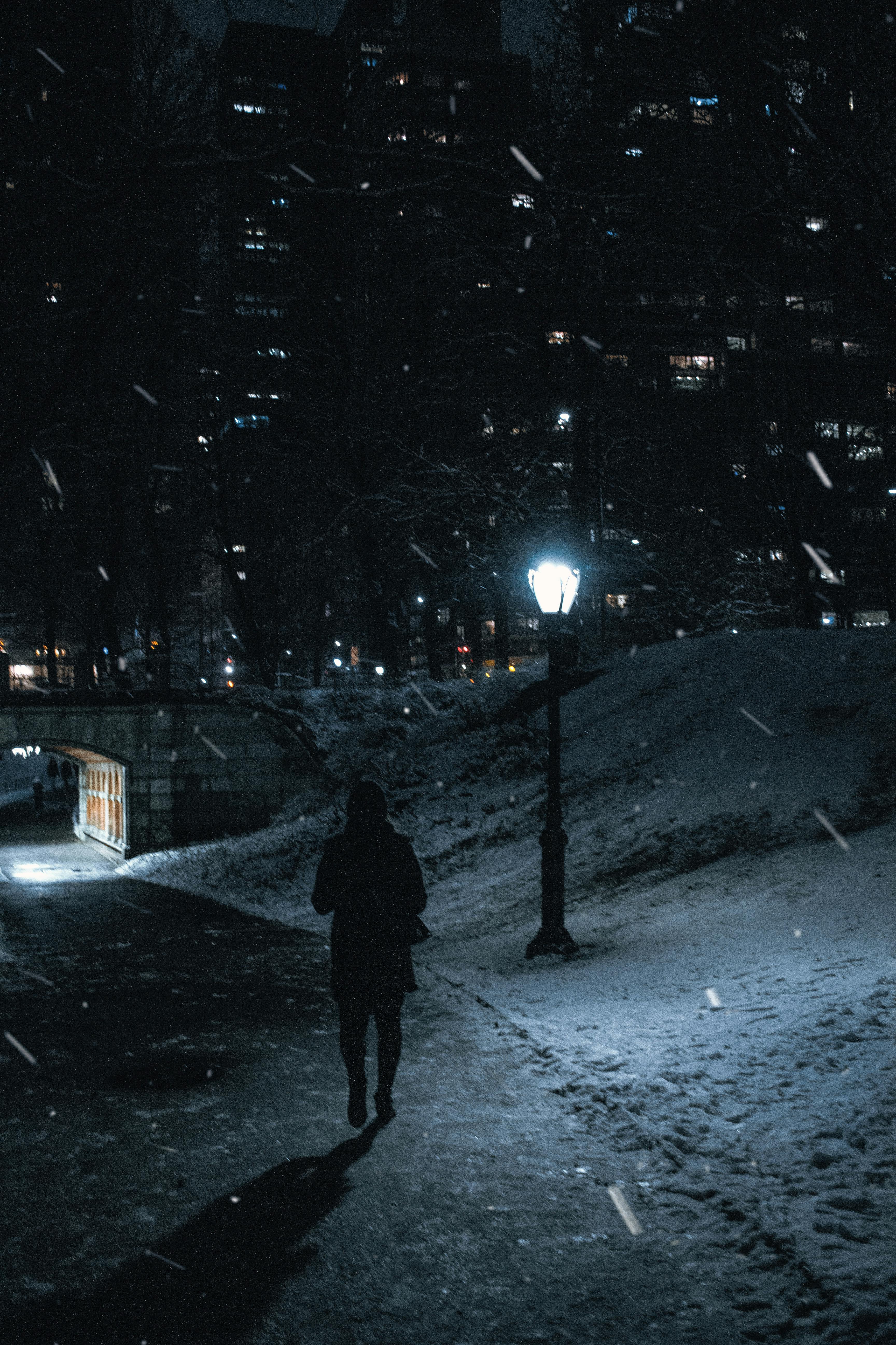 Man Walking on Sidewalk on Snowy Night · Free Stock Photo
