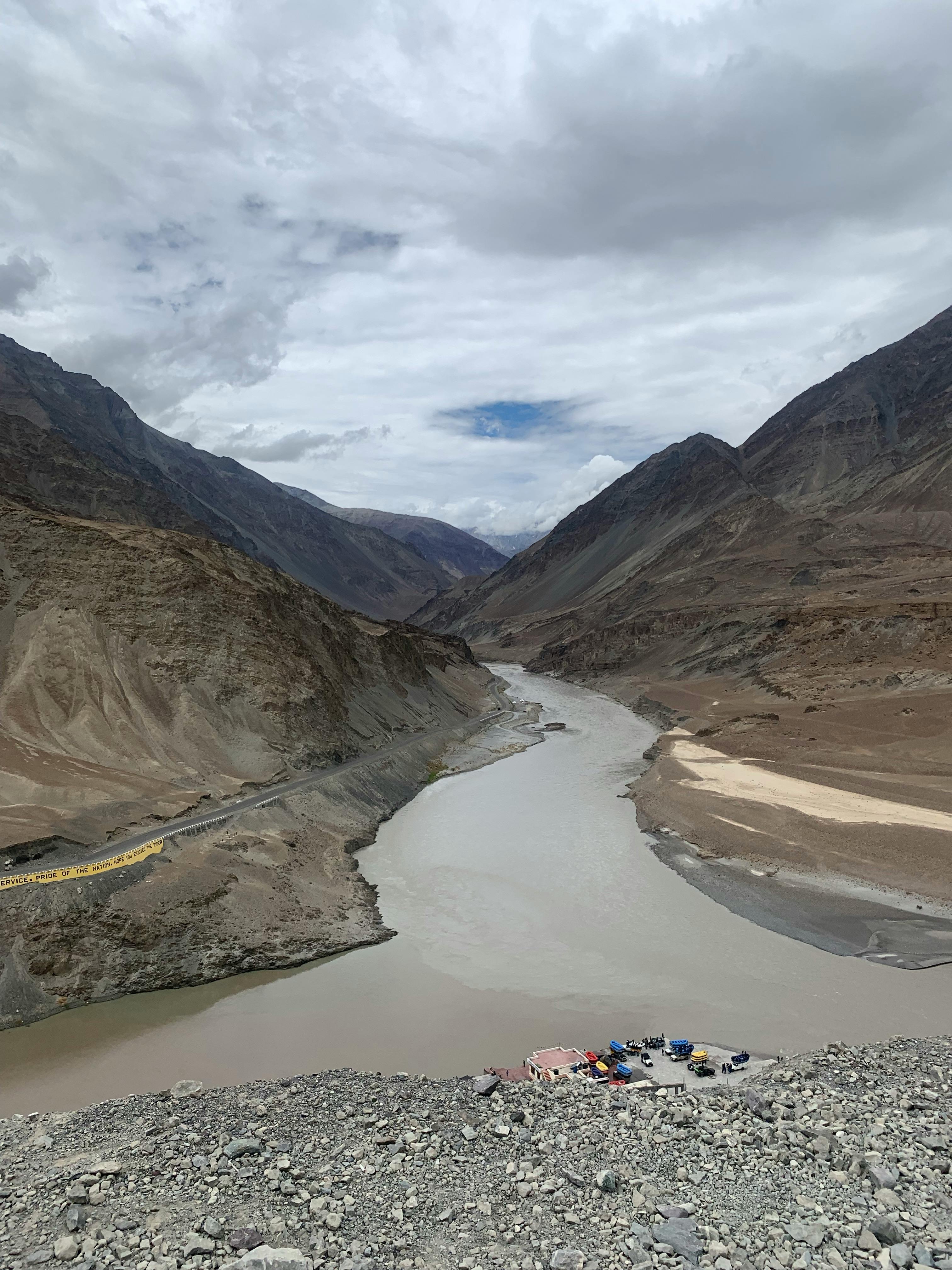 Man by the River in a Mountain Valley · Free Stock Photo
