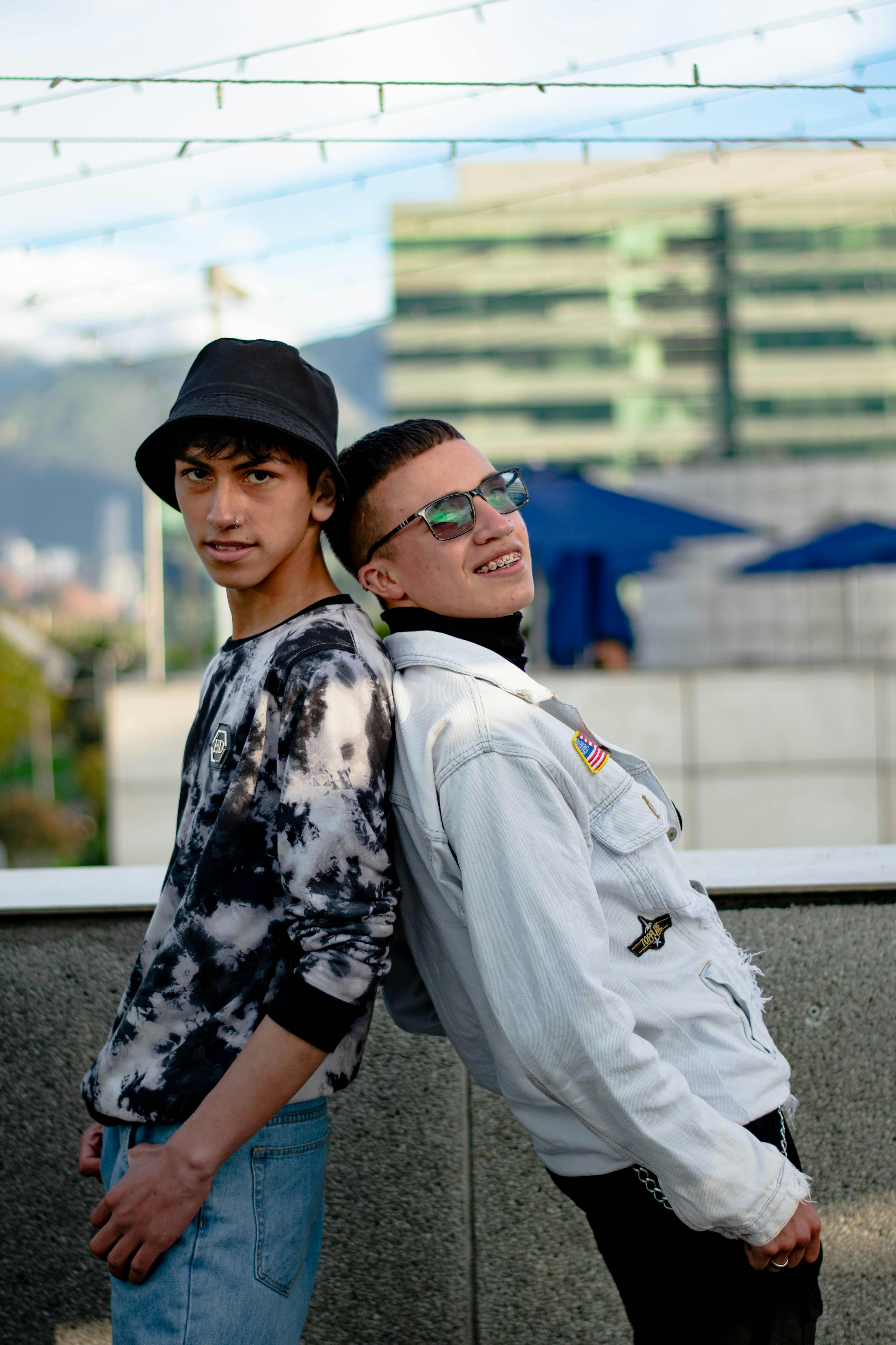 Two Boys Standing Back to Back · Free Stock Photo