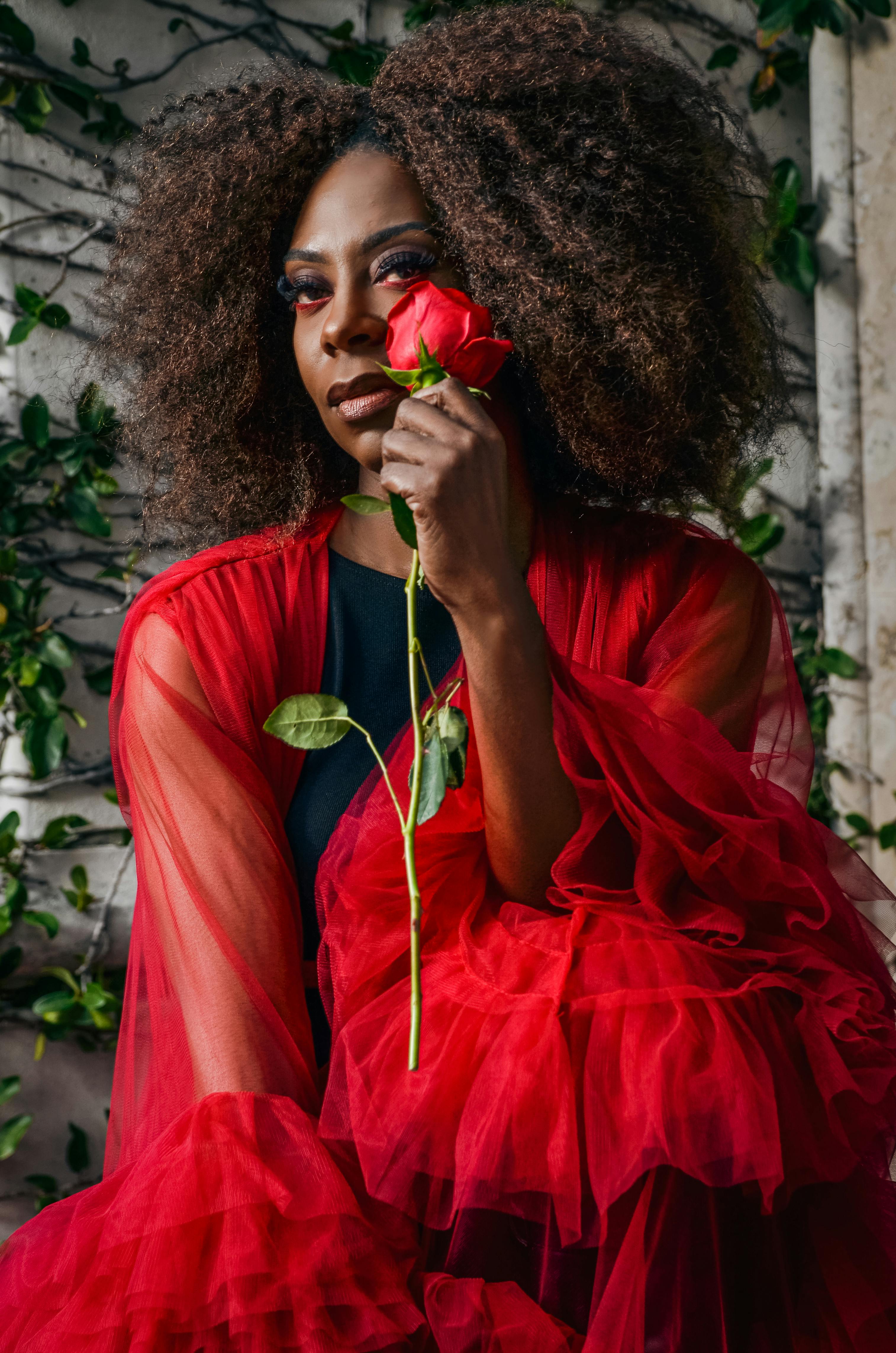 Woman in Red Lace Dress Holding a Red Rose · Free Stock Photo