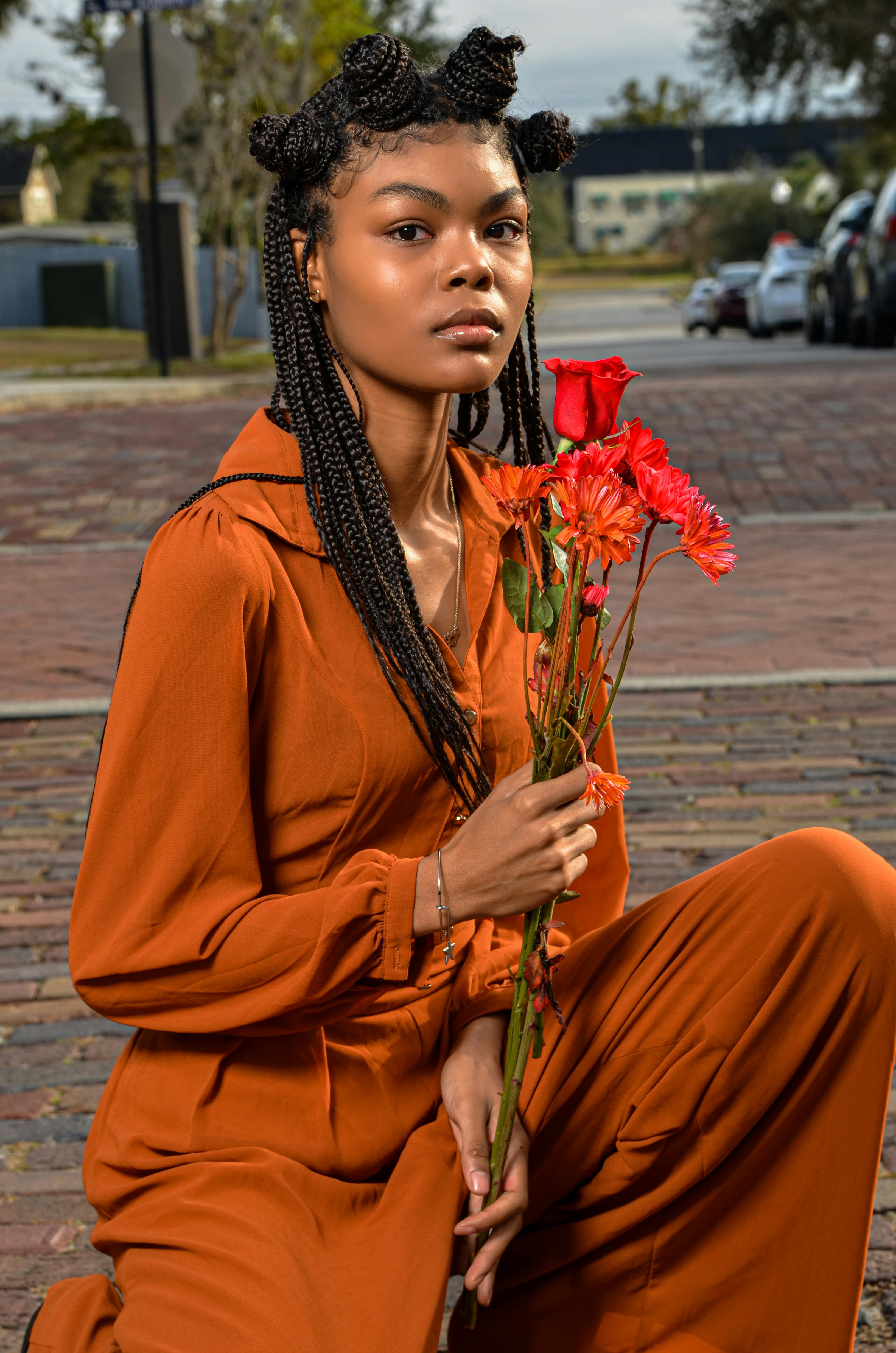 Woman with Dreadlocks Posing with Flowers · Free Stock Photo