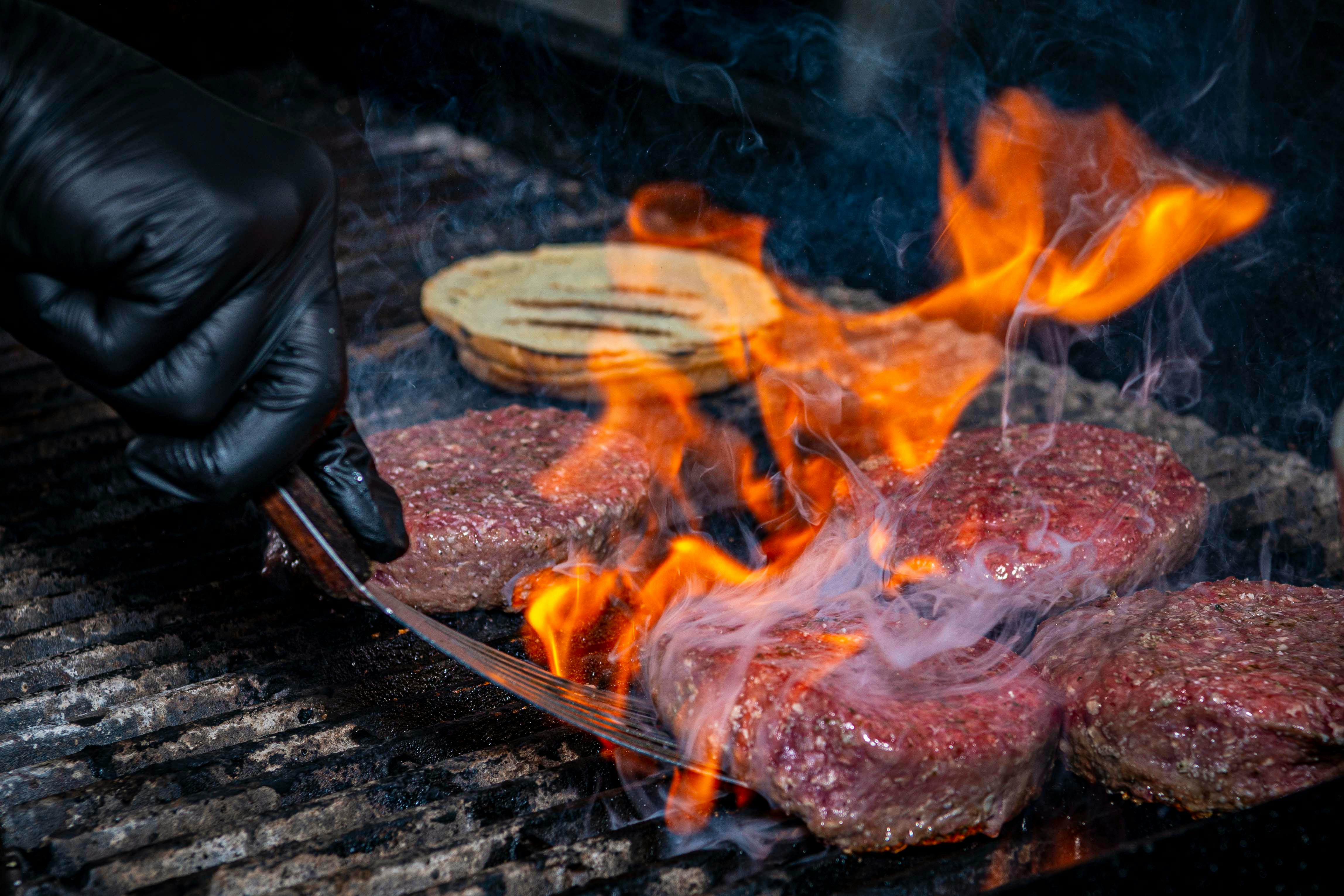 Person Grilling a Steak · Free Stock Photo